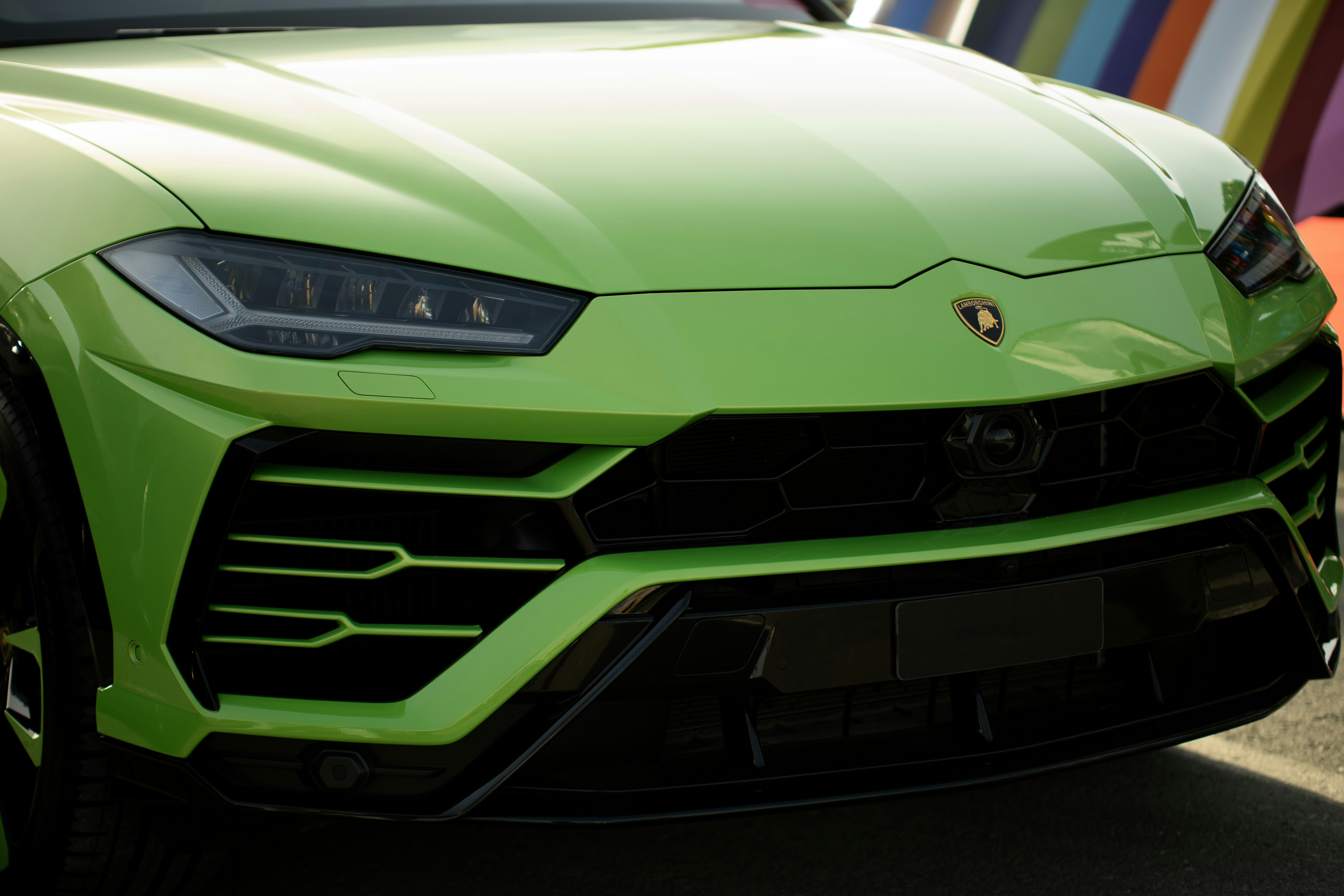 Lime Fury at the Grille: Neon Lamborghini Front End in Daylight