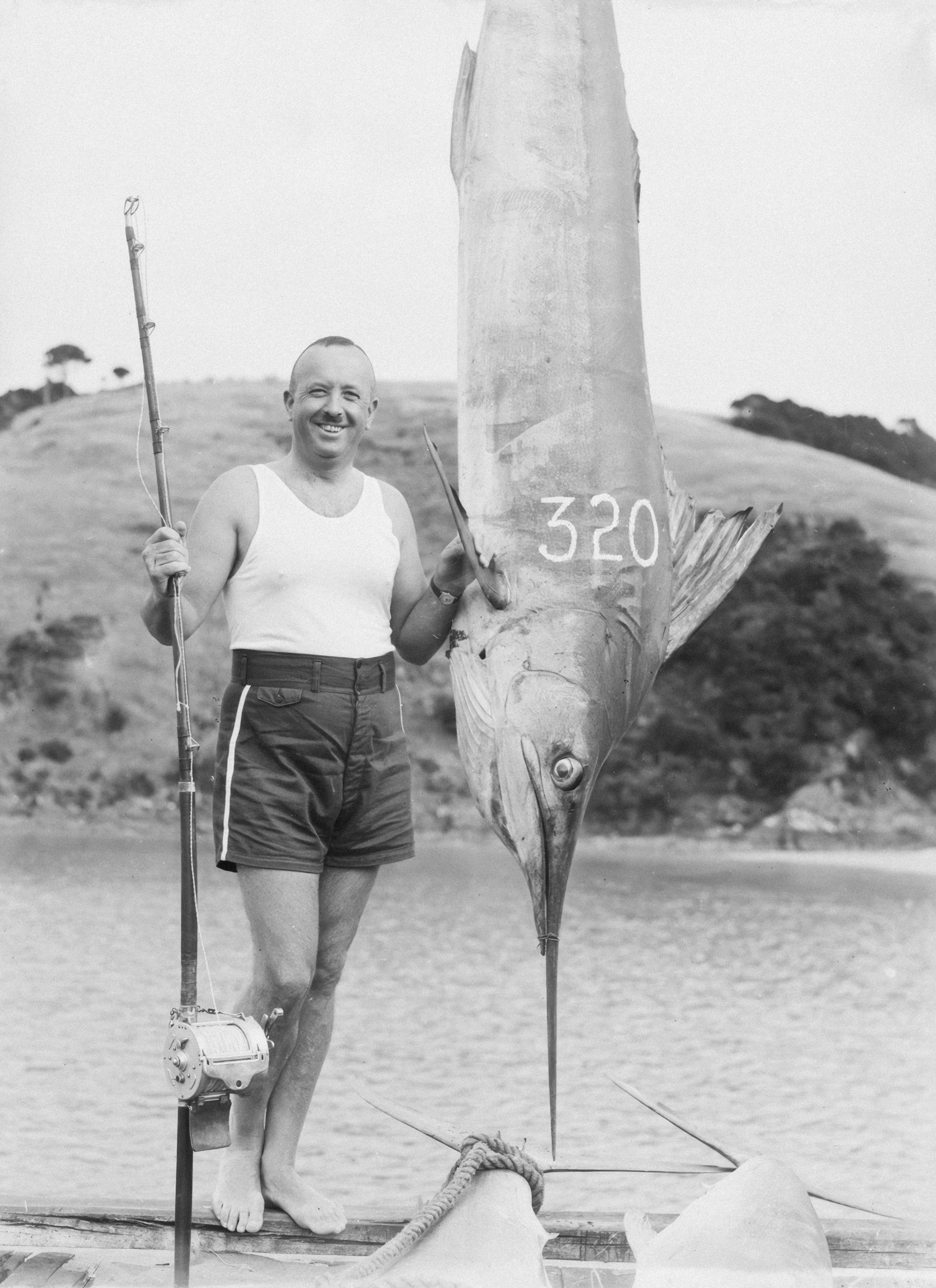 Dockside Triumph: A Man and the Marlin Marked 320