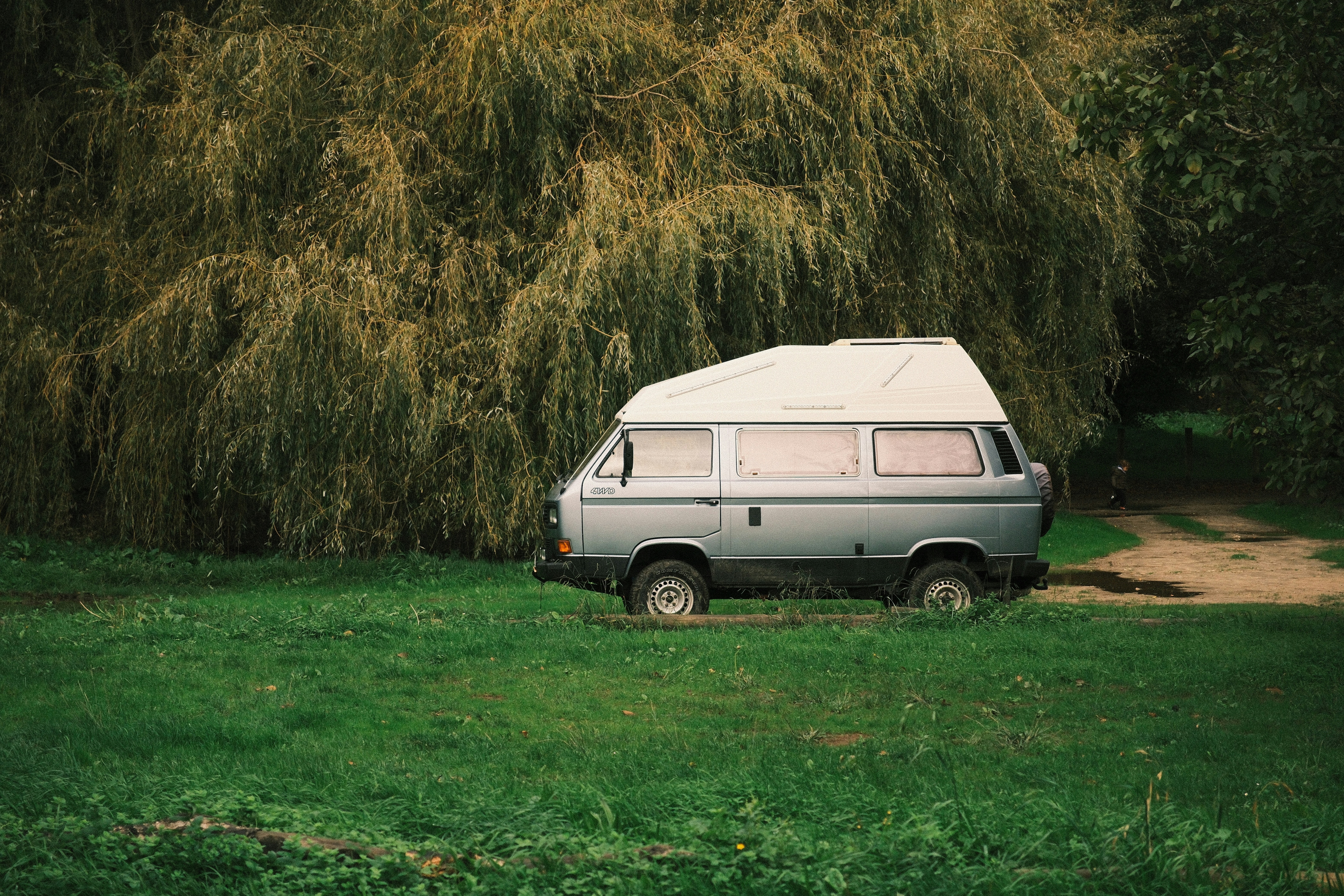 A silver camper van parked in a grassy field. photo – Free Car Image on ...