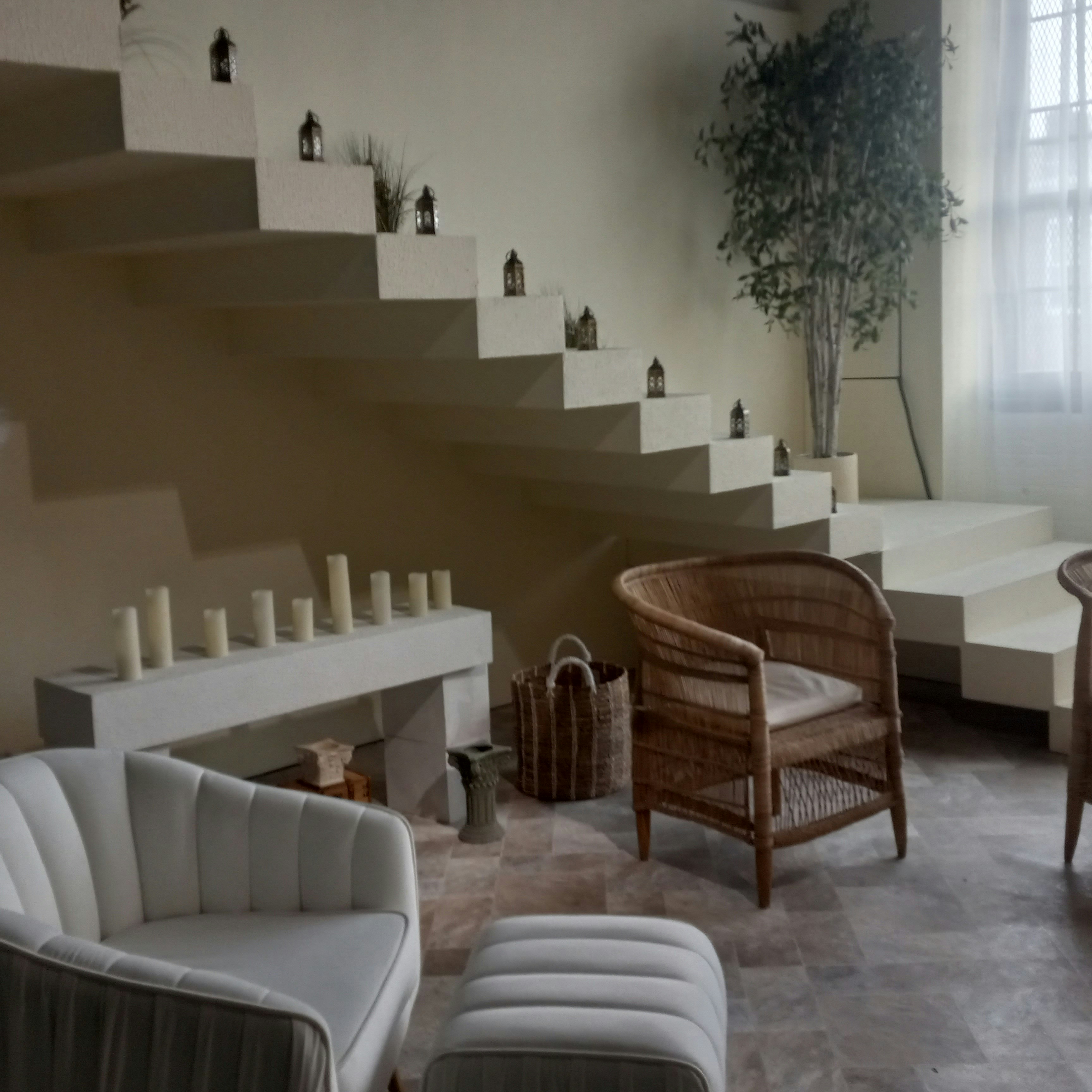 Cozy interior featuring a modern staircase, stylish seating, and soft lighting elements that create a tranquil ambiance.