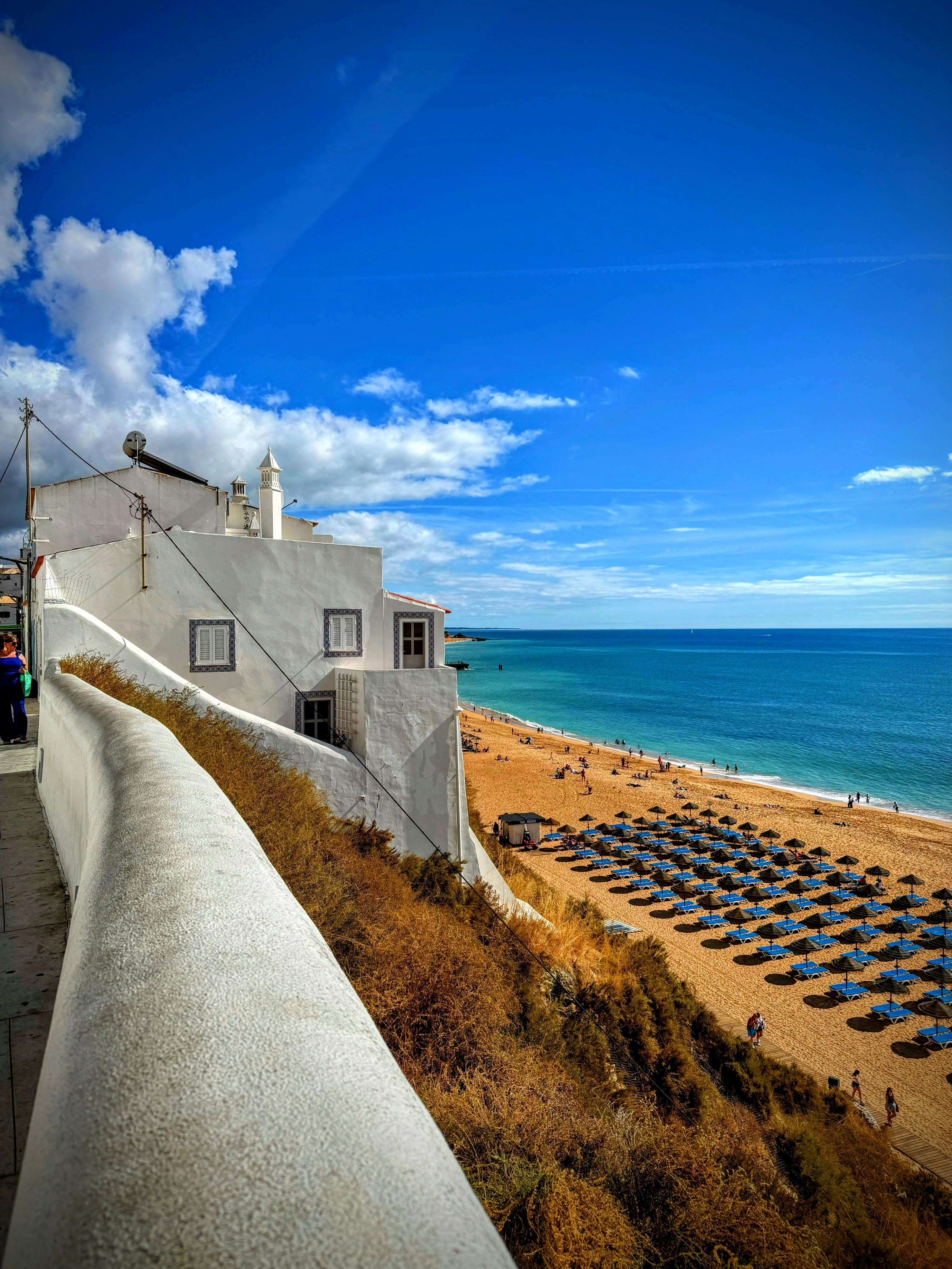 White-Walled Promenade Guiding the Eye Toward a Turquoise Sea