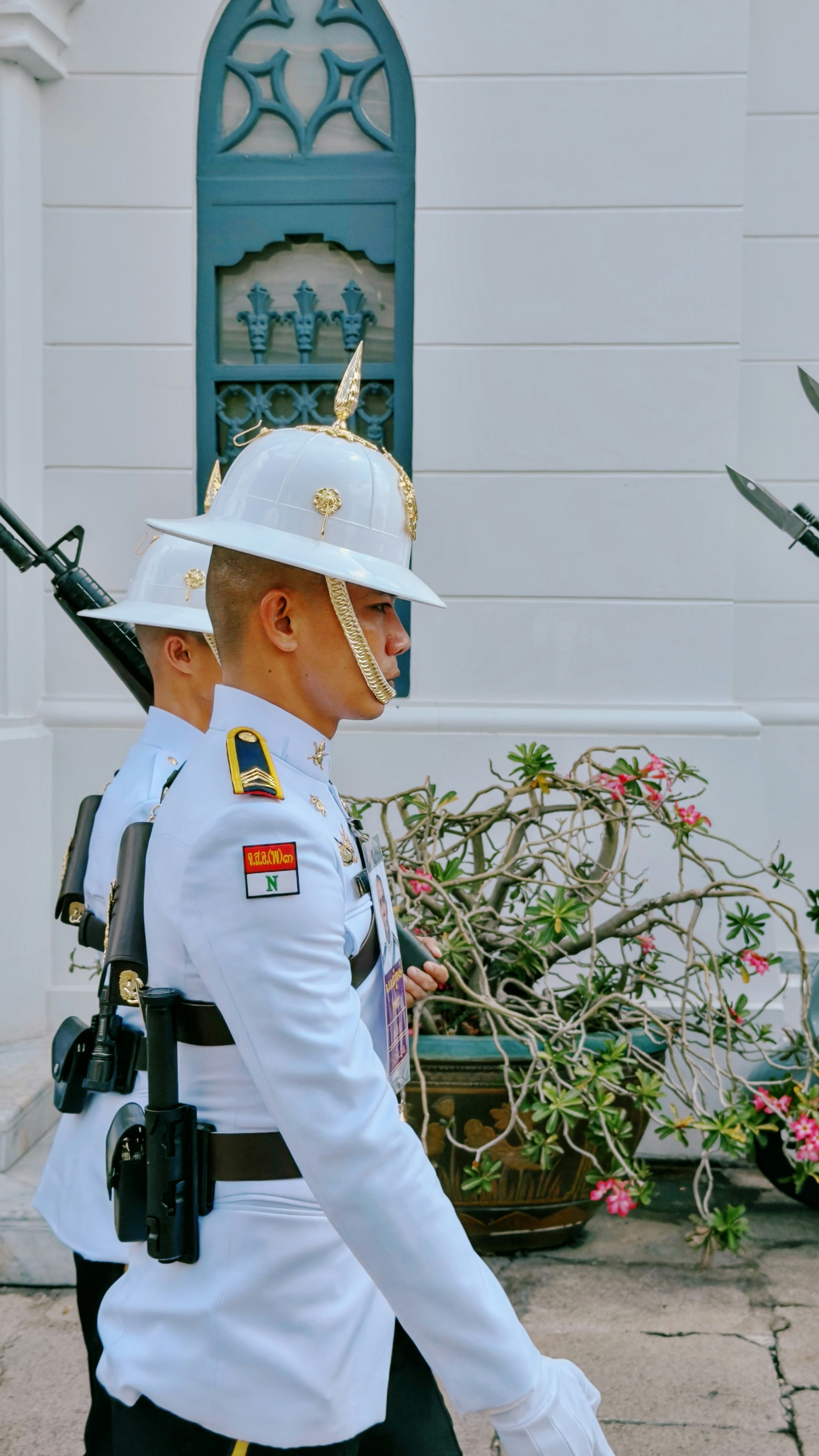 Ivory-Uniform Sentinel at a Sunlit Courtyard Ceremony