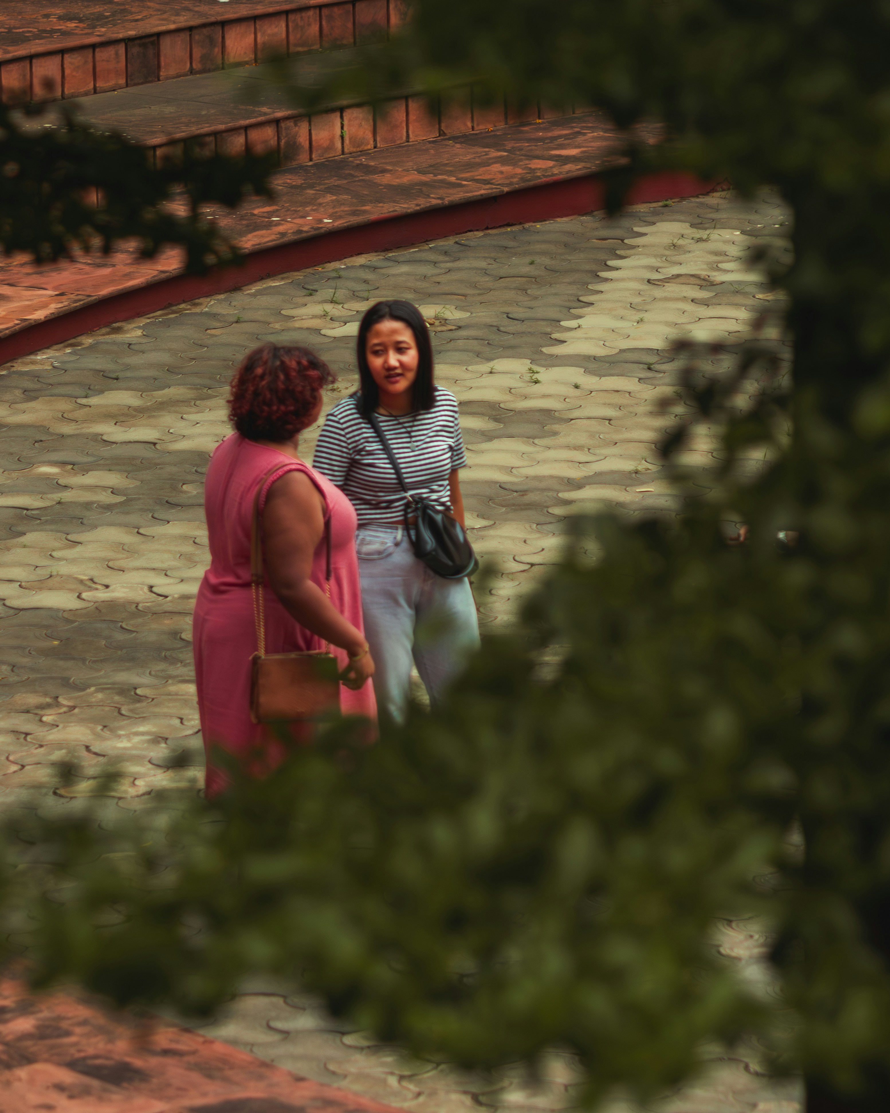 Conversations Under the Arch: Two Women in Conversation on a Sunlit Path