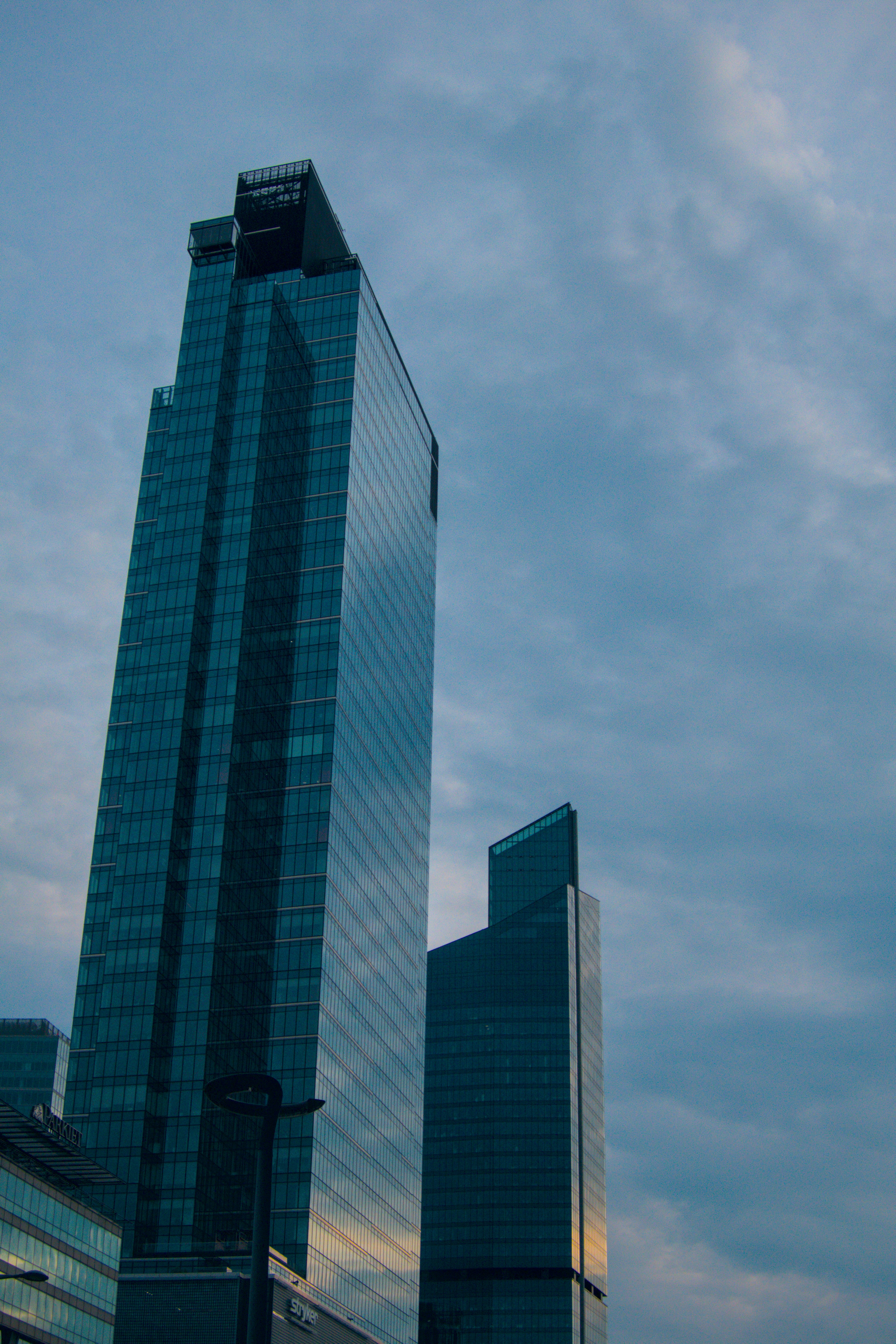Modern glass skyscrapers against a cloudy sky
