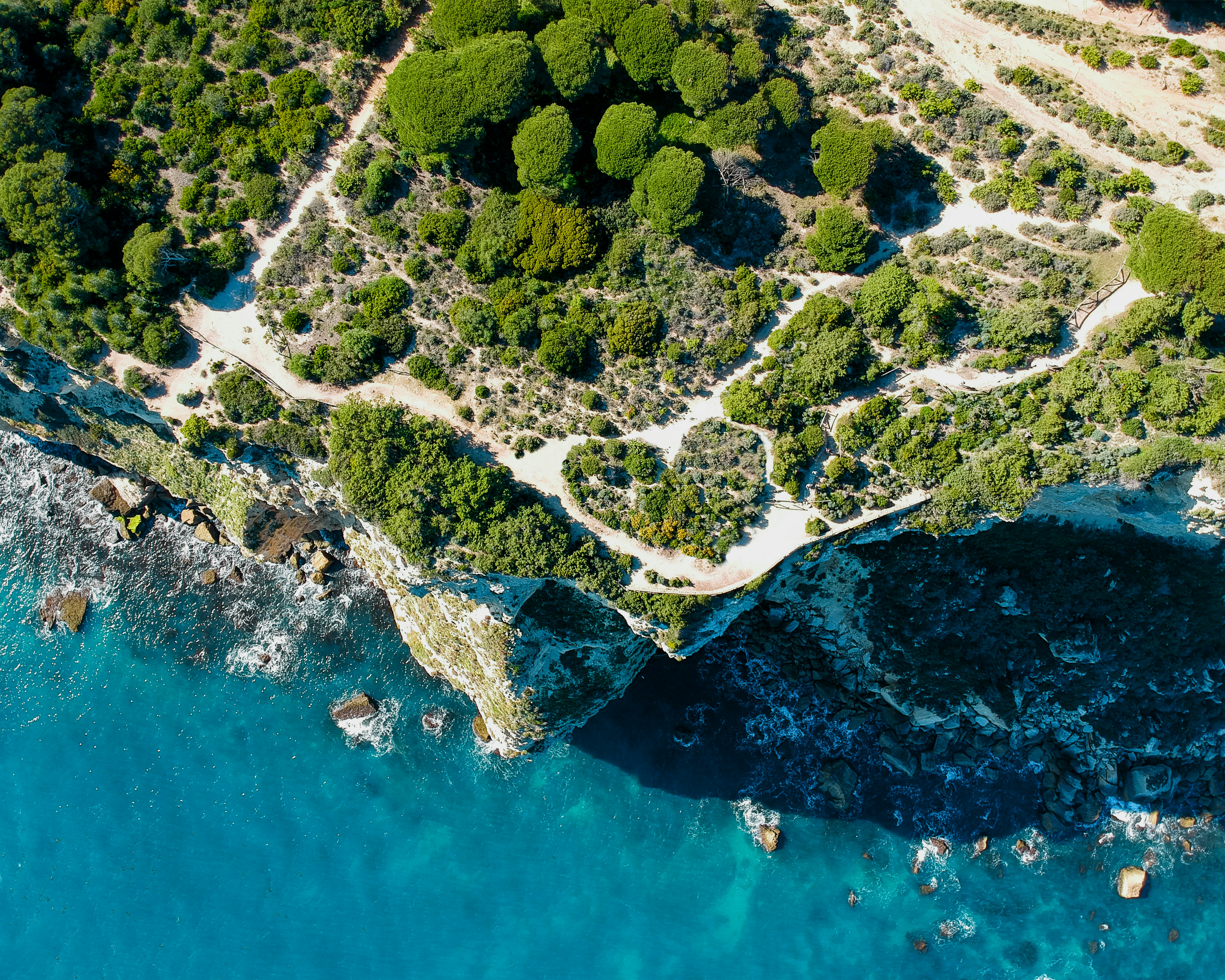 Verdant Cliffs Embracing Turquoise Waters