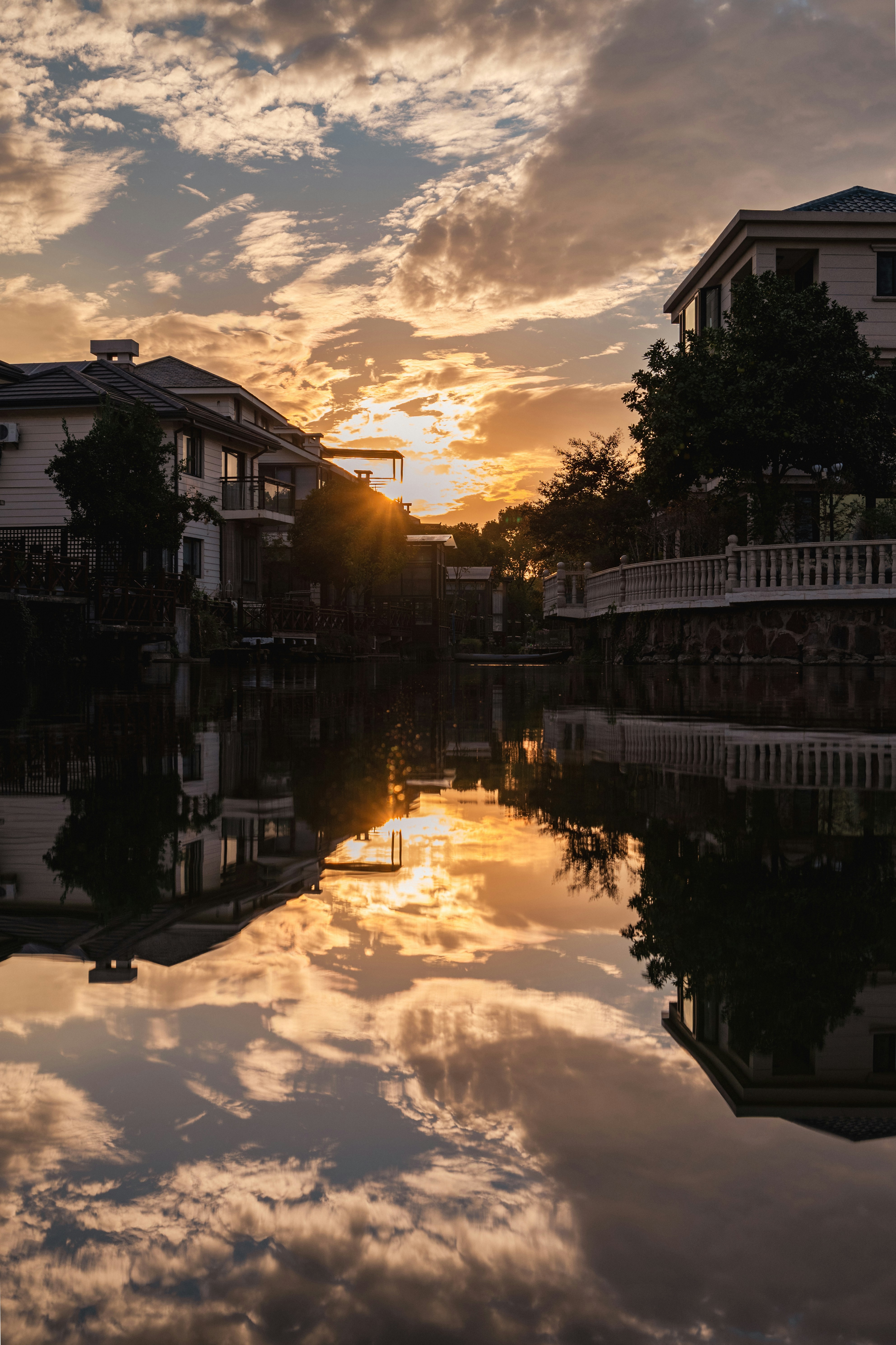 Sunset on a Glassy Canal: Reflections and Quiet Architecture