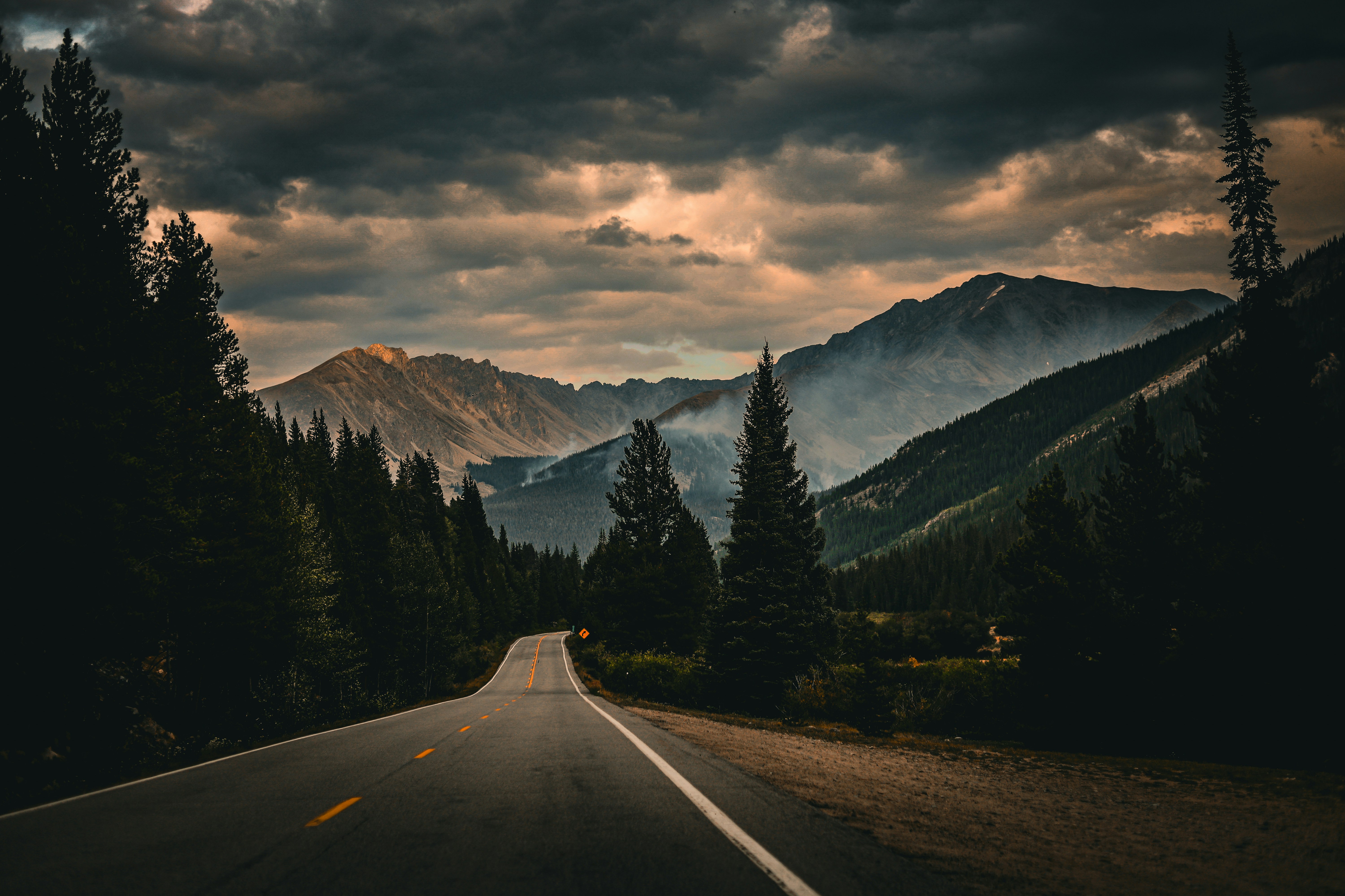The Silent Vanishing Point: Mountain Road at Golden Hour