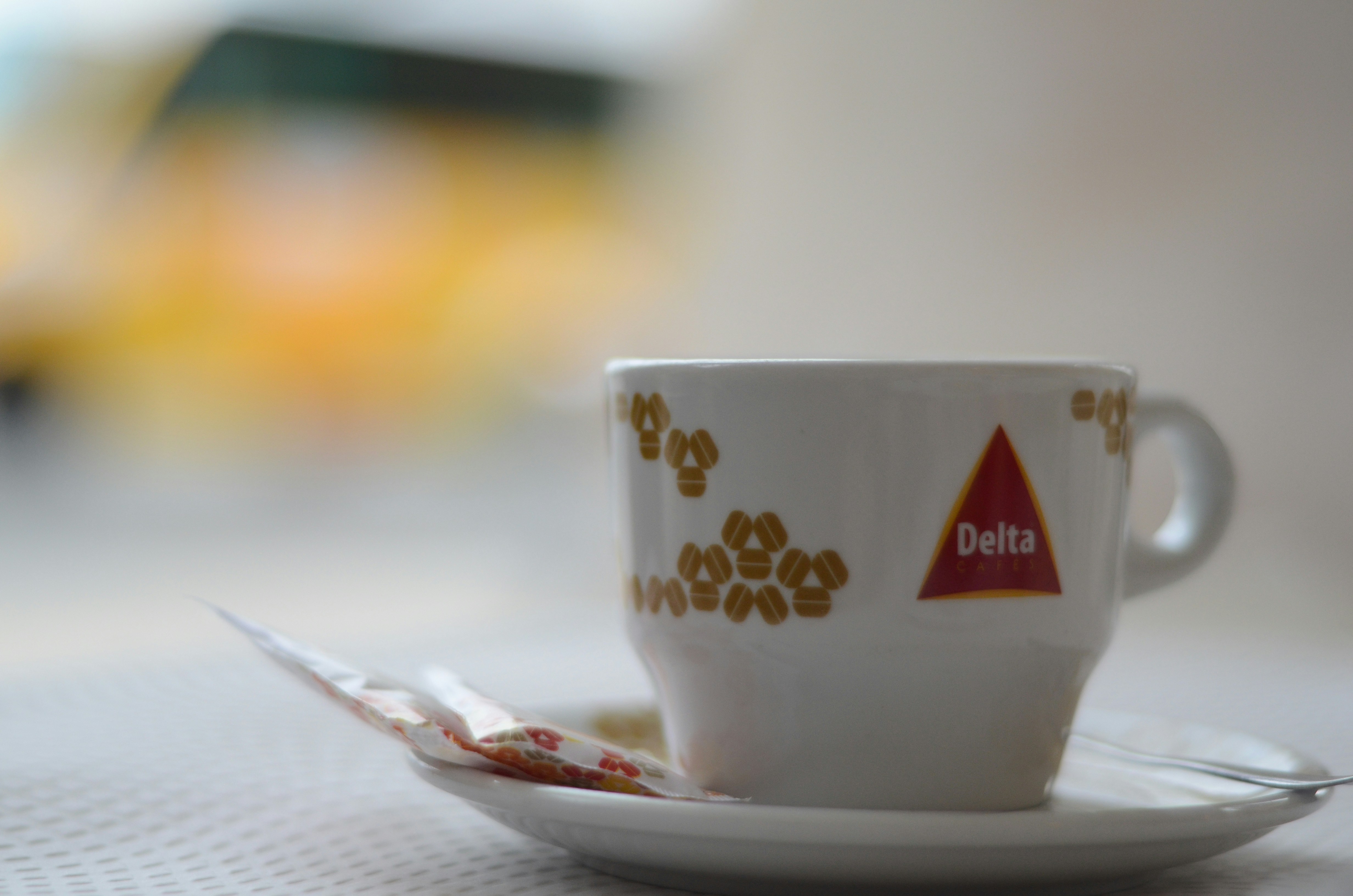 White coffee cup with delta logo and pattern photo – Free Cafe Image on ...