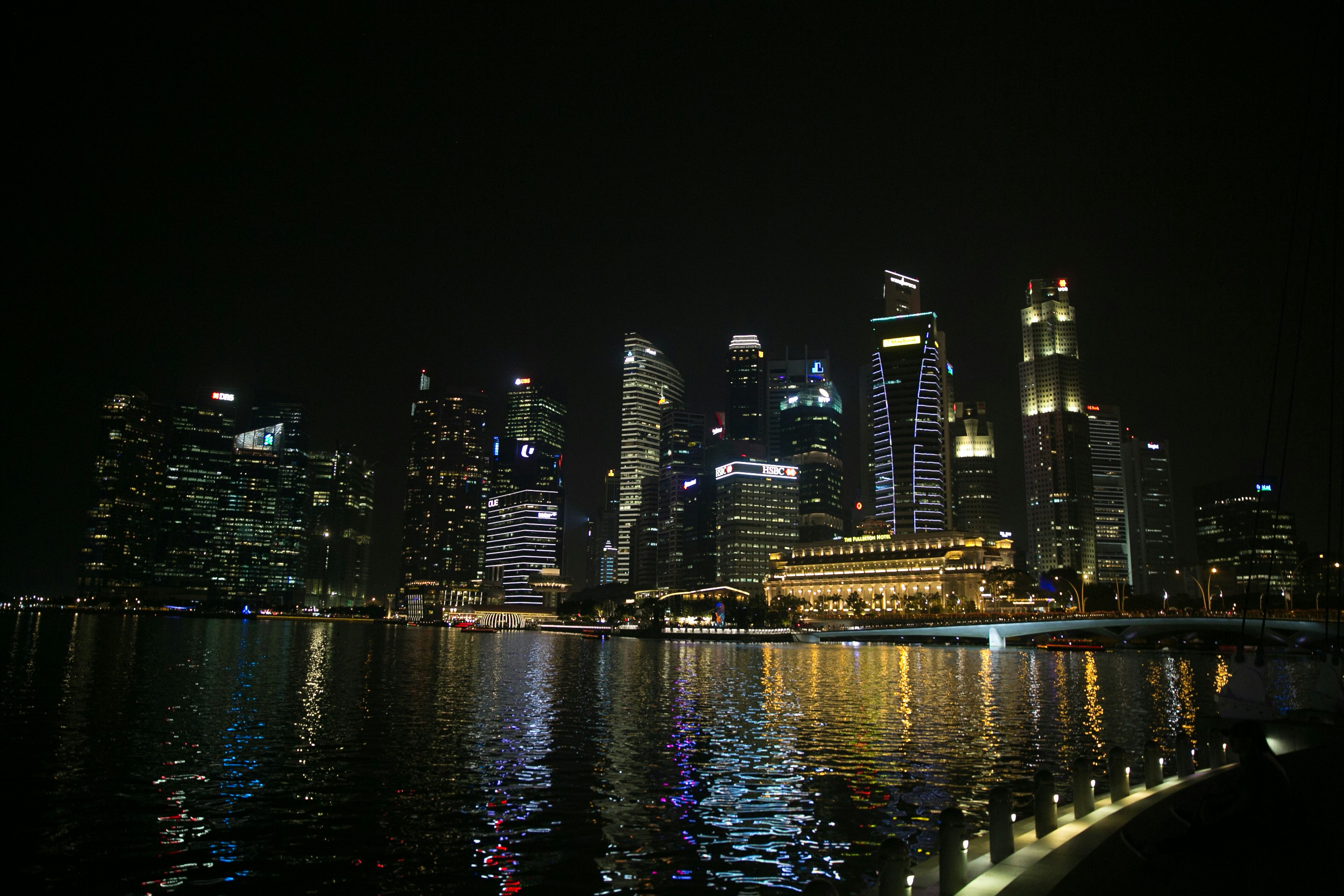 Vibrant cityscape skyline at night with water reflections