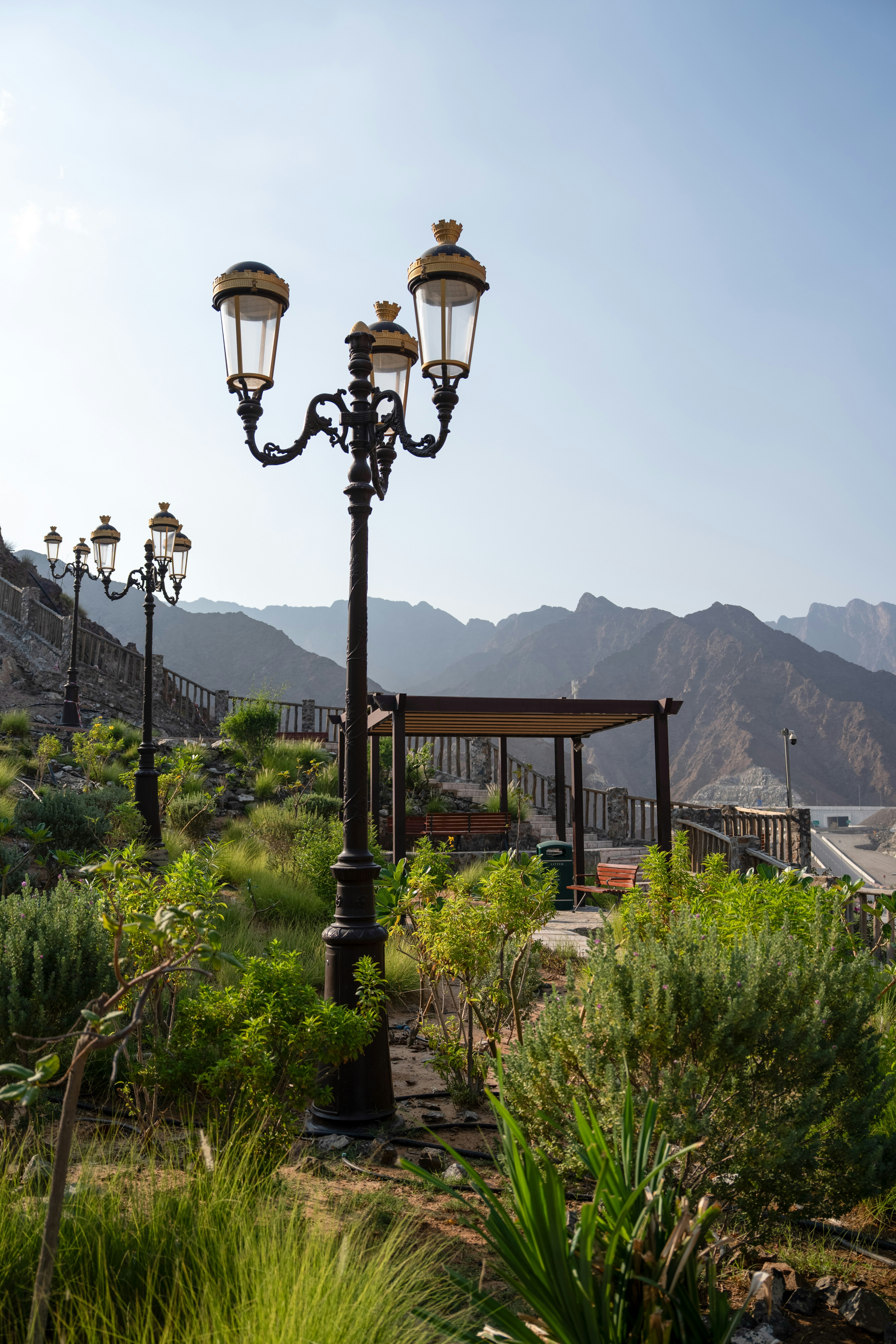 Iron-Lantern Terrace Against a Mountain Horizon