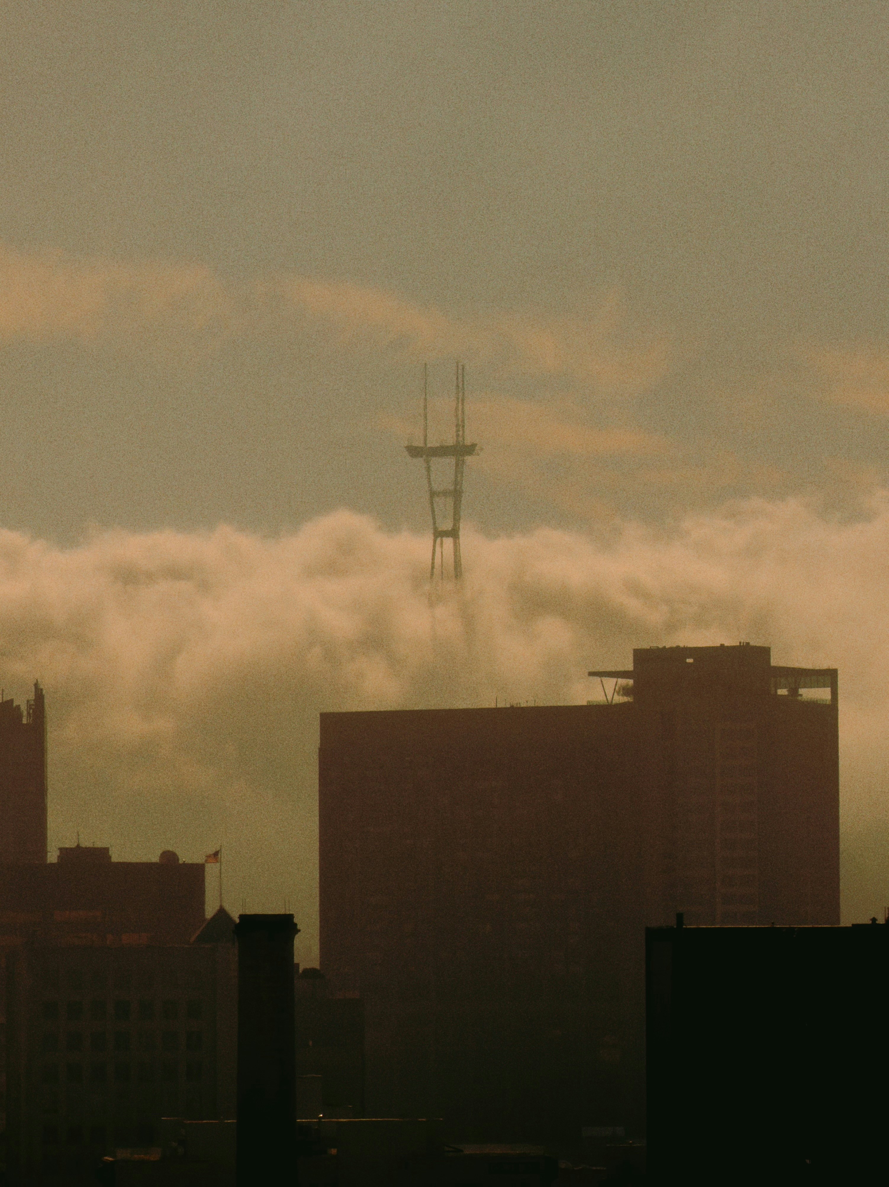 Veil of Clouds Over Urban Spires