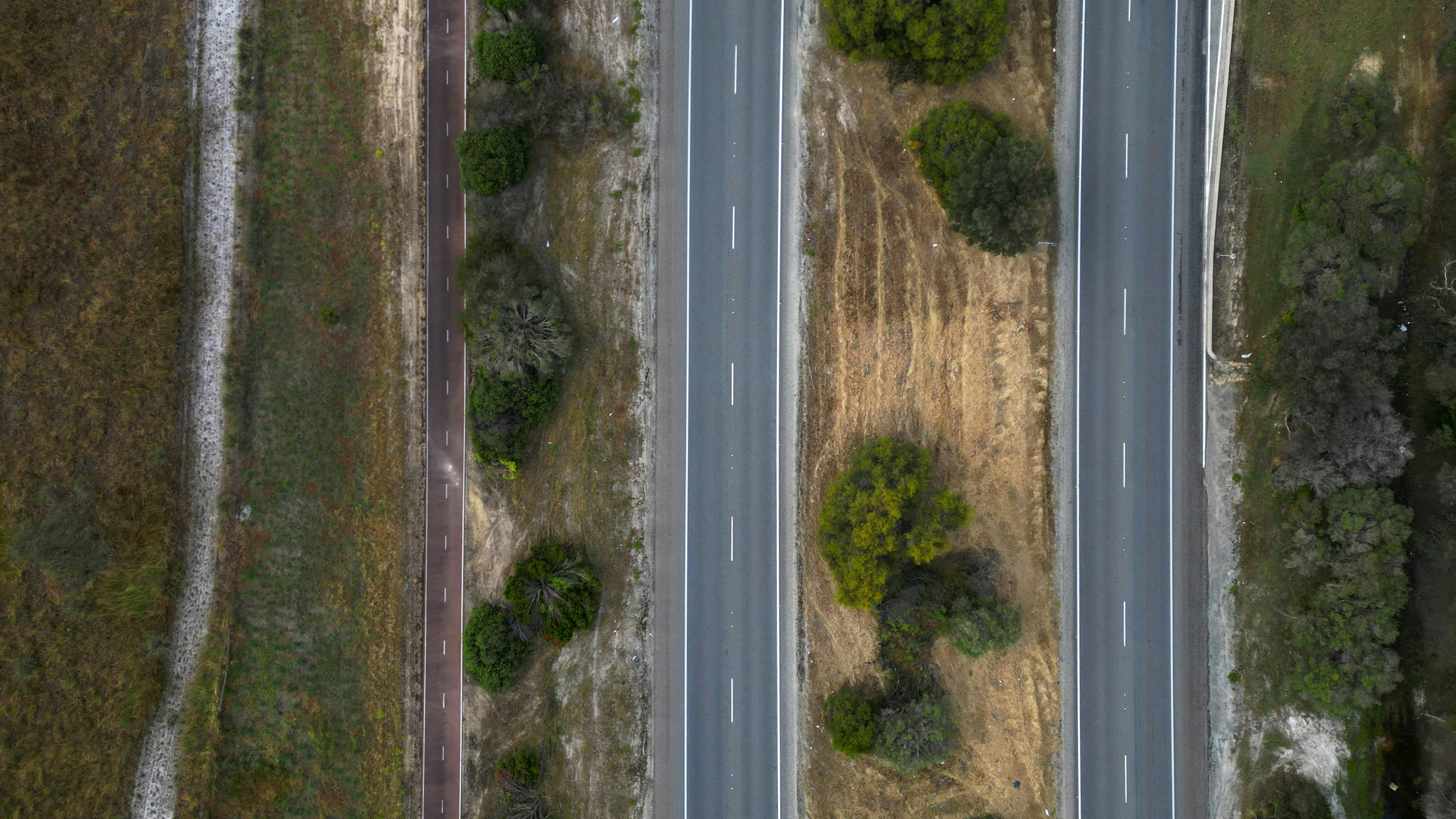 Aerial view of a highway with surrounding vegetation.