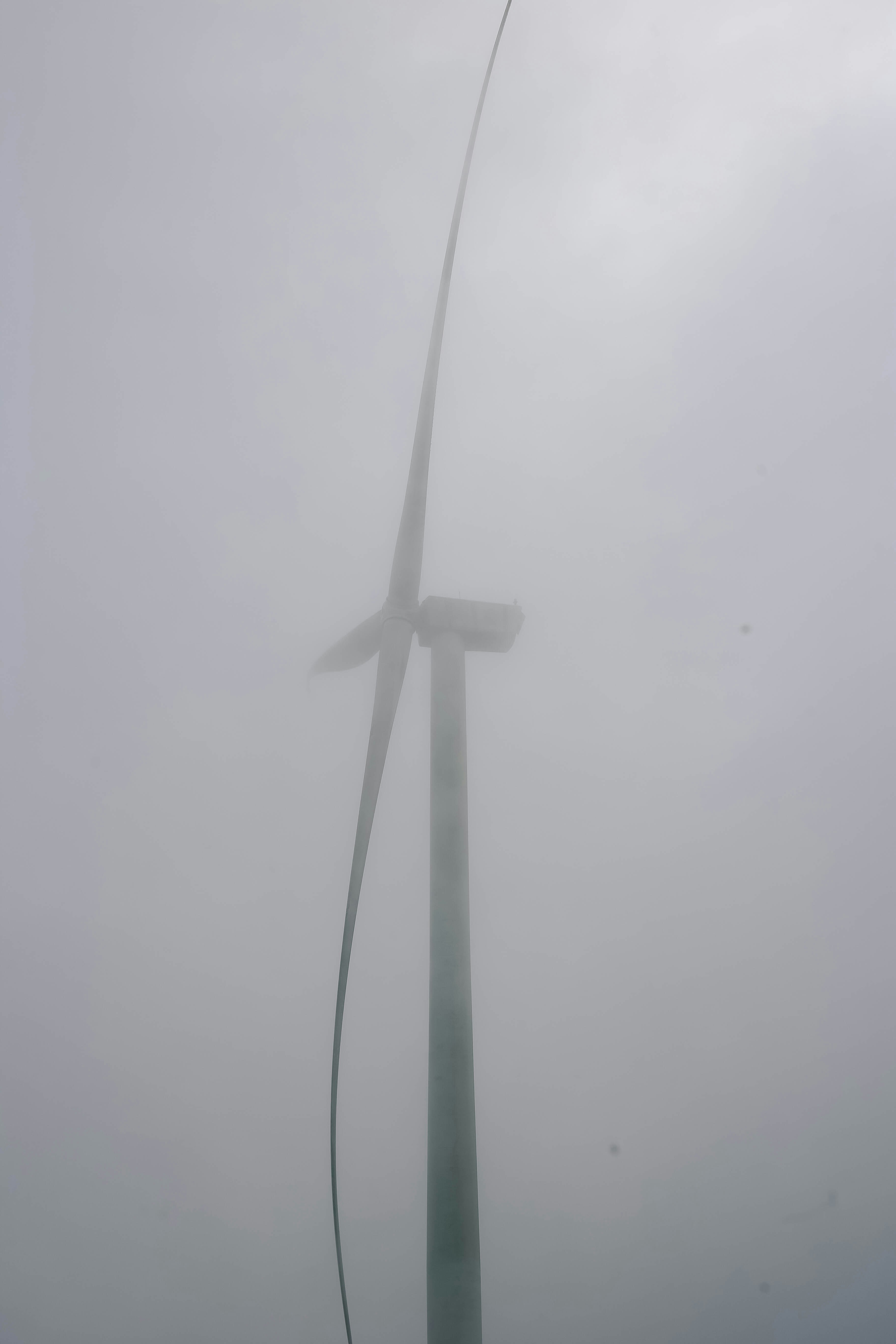 Whispers of the Wind: A Turbine's Solitude in the Mist