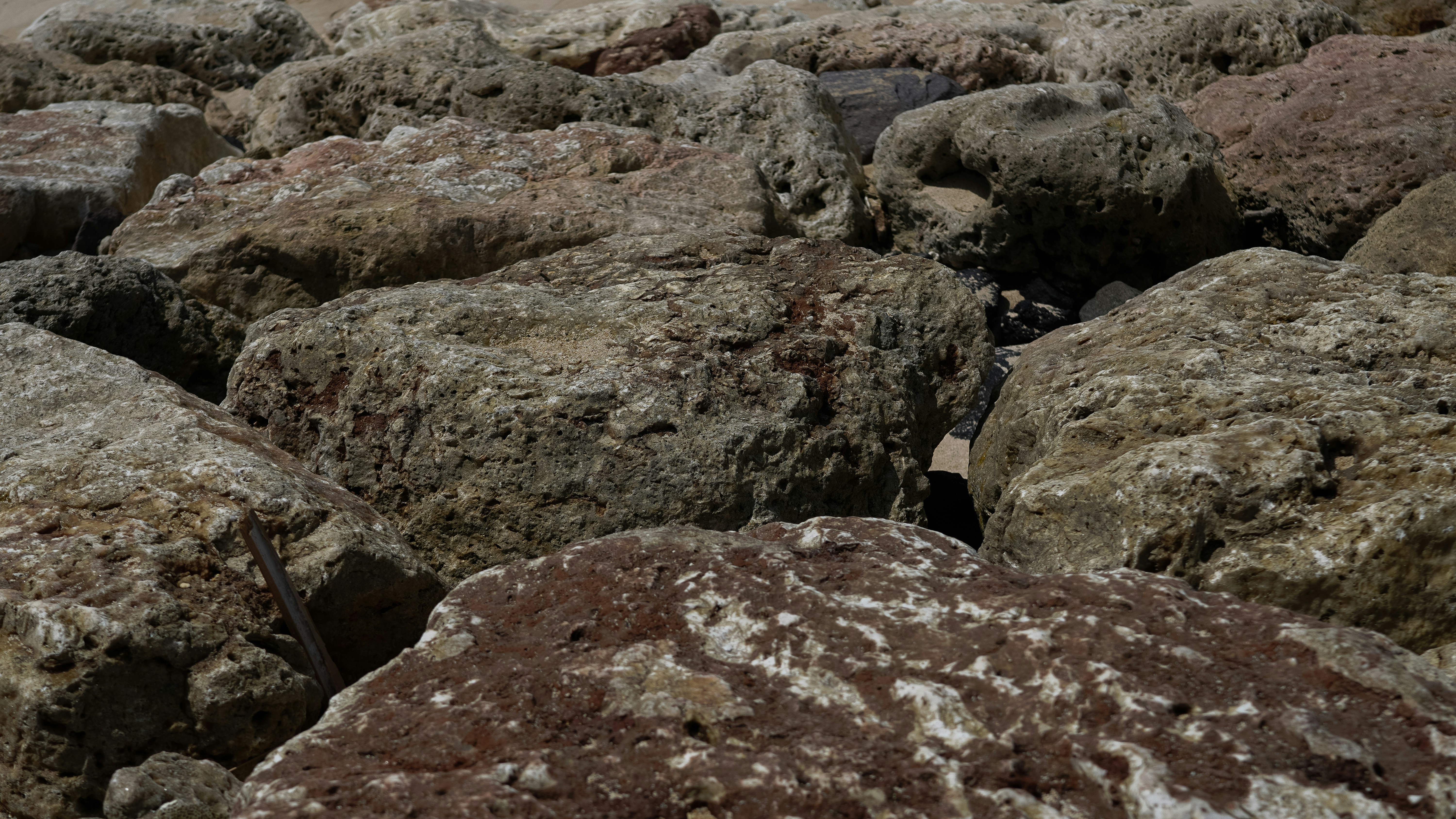 Large, rough rocks piled together outdoors.