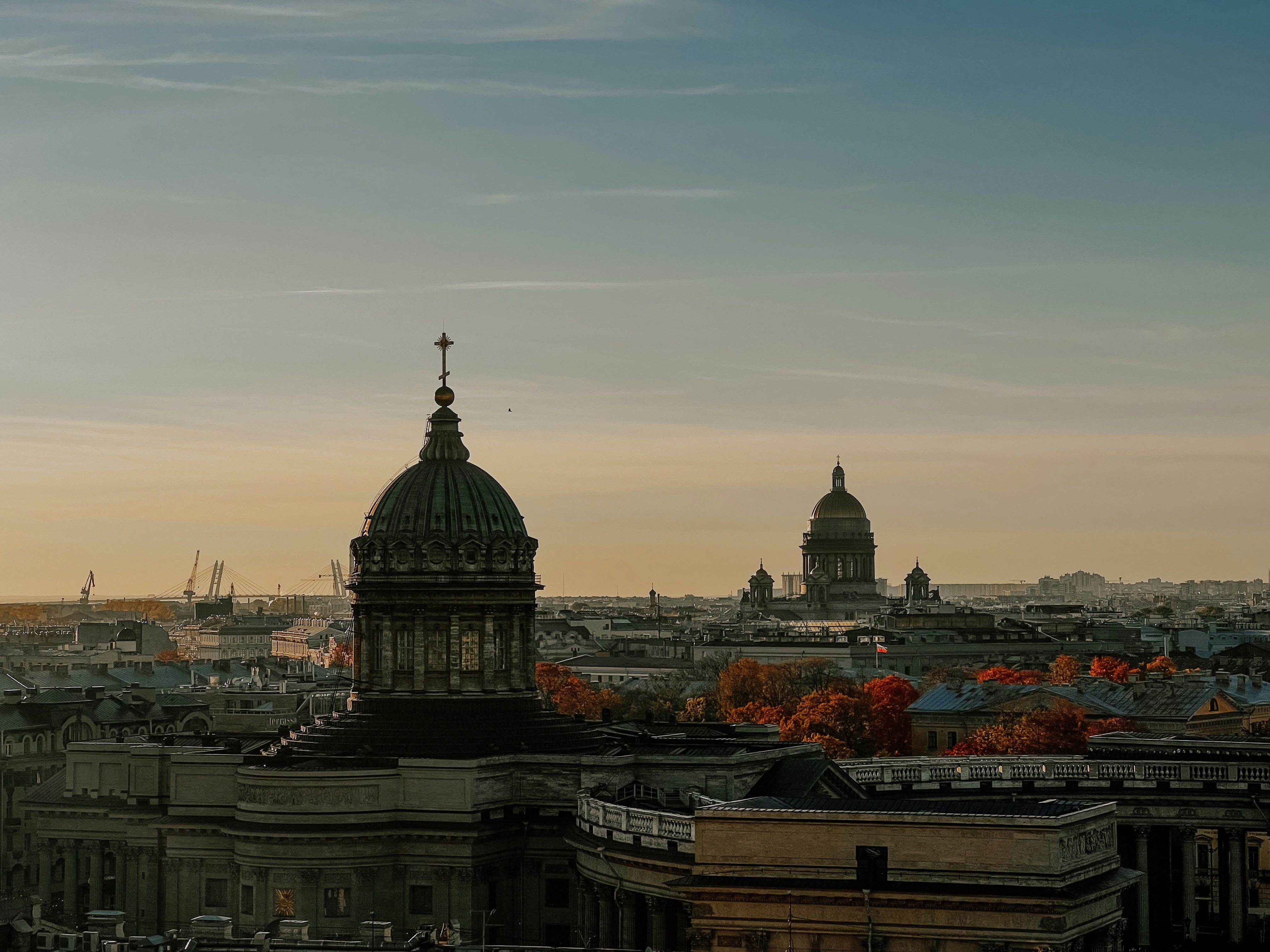 Historic domes silhouetted against a soft sunset sky, showcasing the rich architectural heritage of the city.