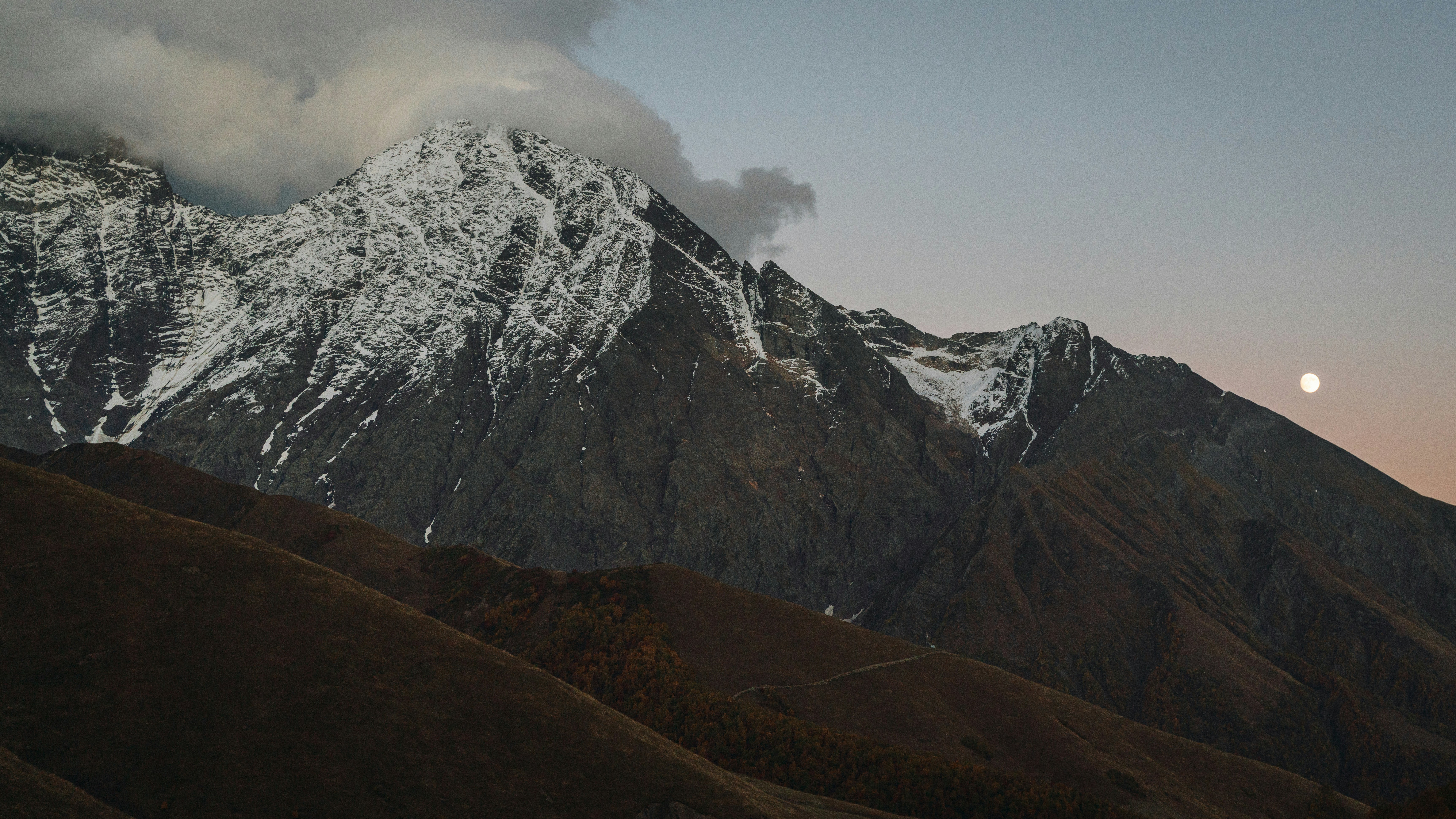 Whispers of Dusk on Snow-Capped Peaks