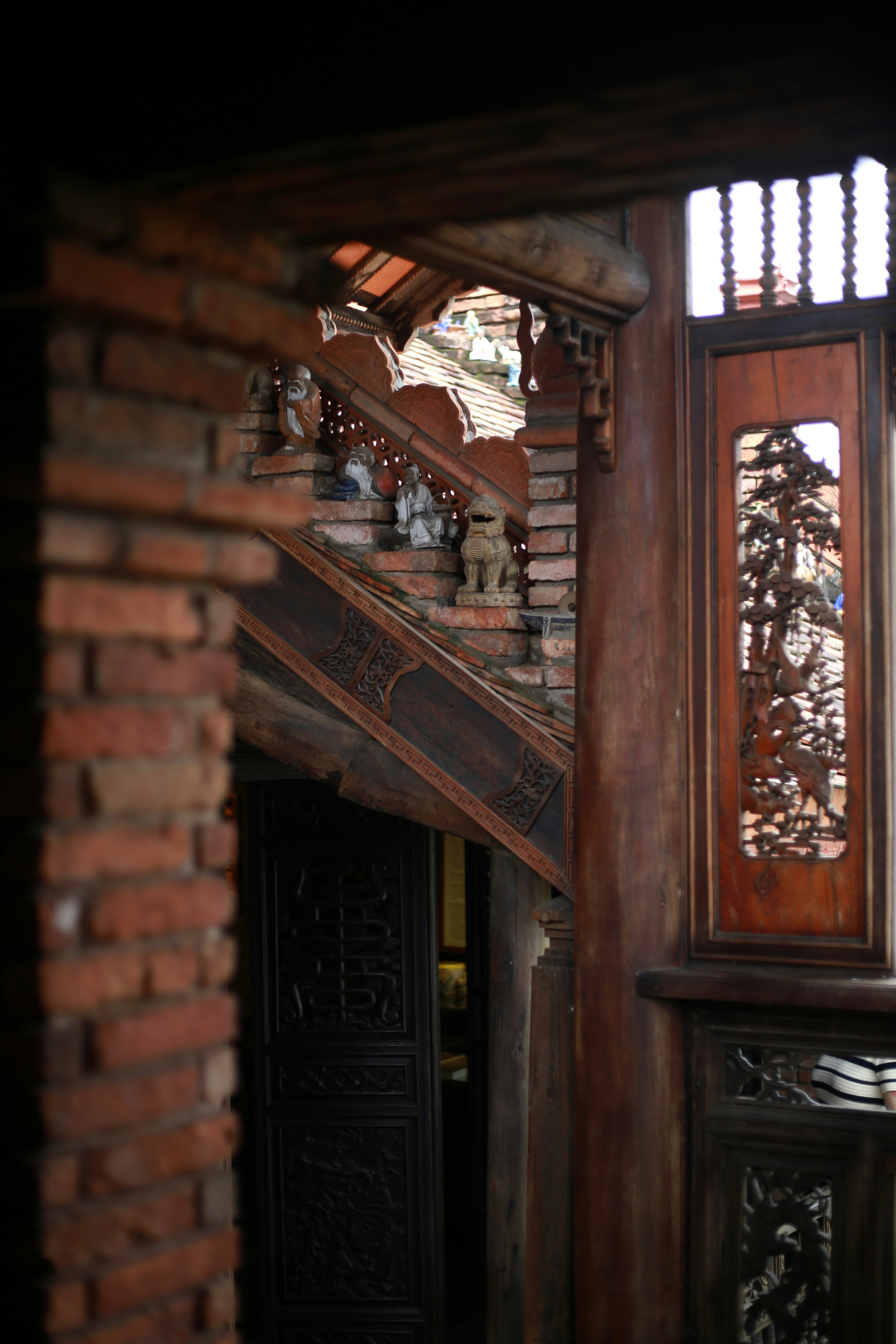 Carved Thresholds: Light on Brick and Wood in an Ancient Hall