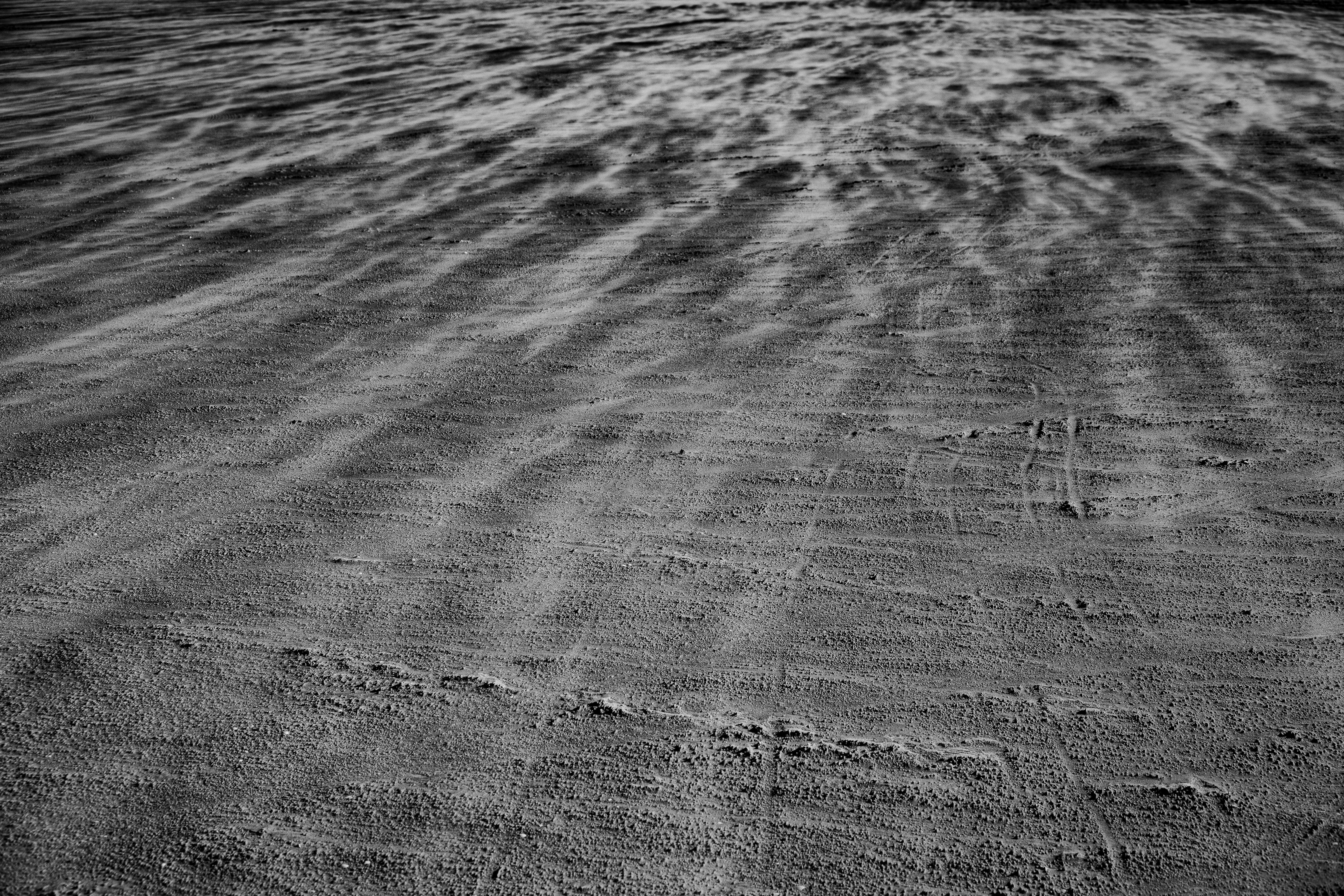 Textured sands with intricate patterns created by wind, showcasing the natural artistry of the desert landscape.