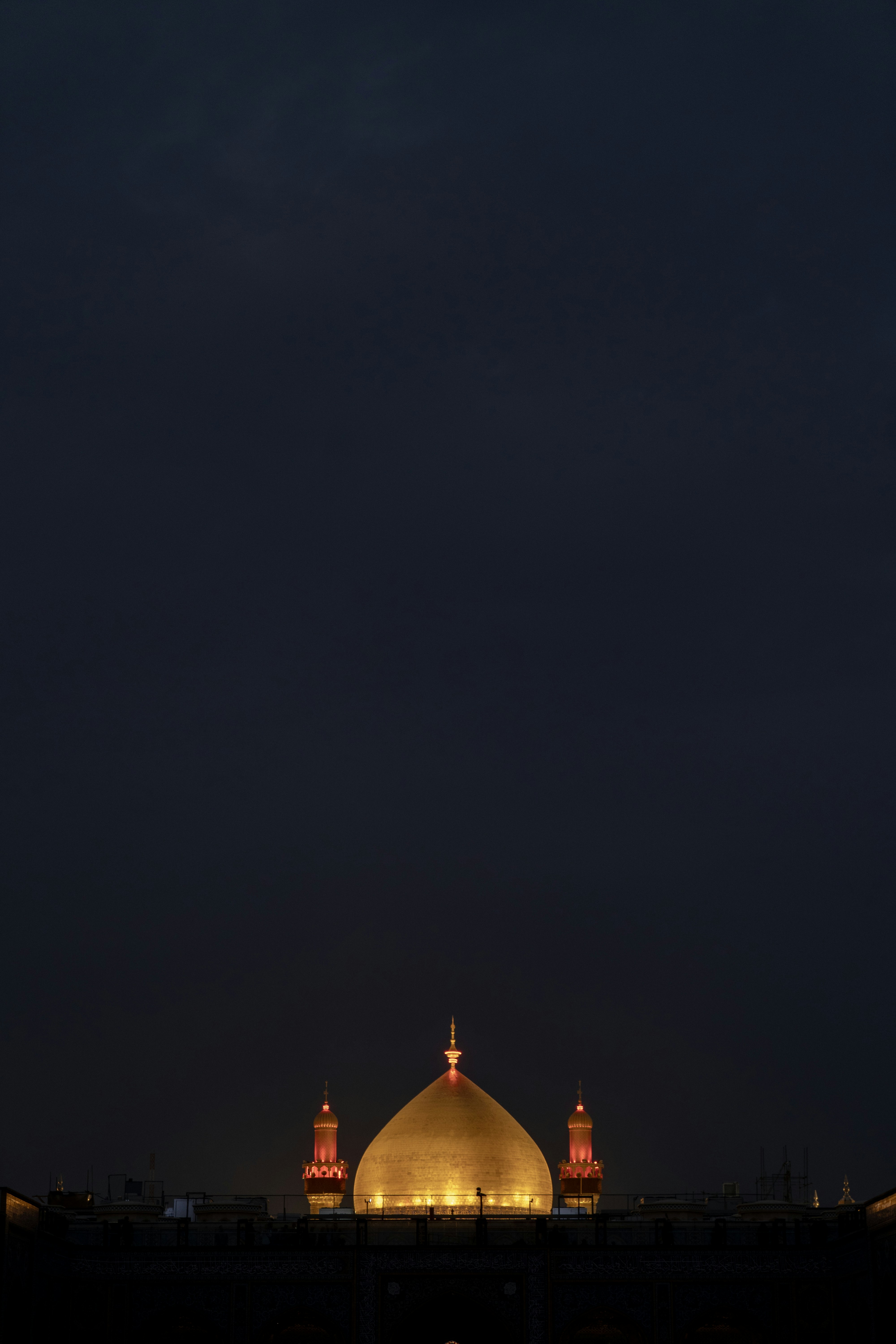 Golden dome of a historic monument illuminated against a darkening sky, showcasing architectural beauty and cultural significance.
