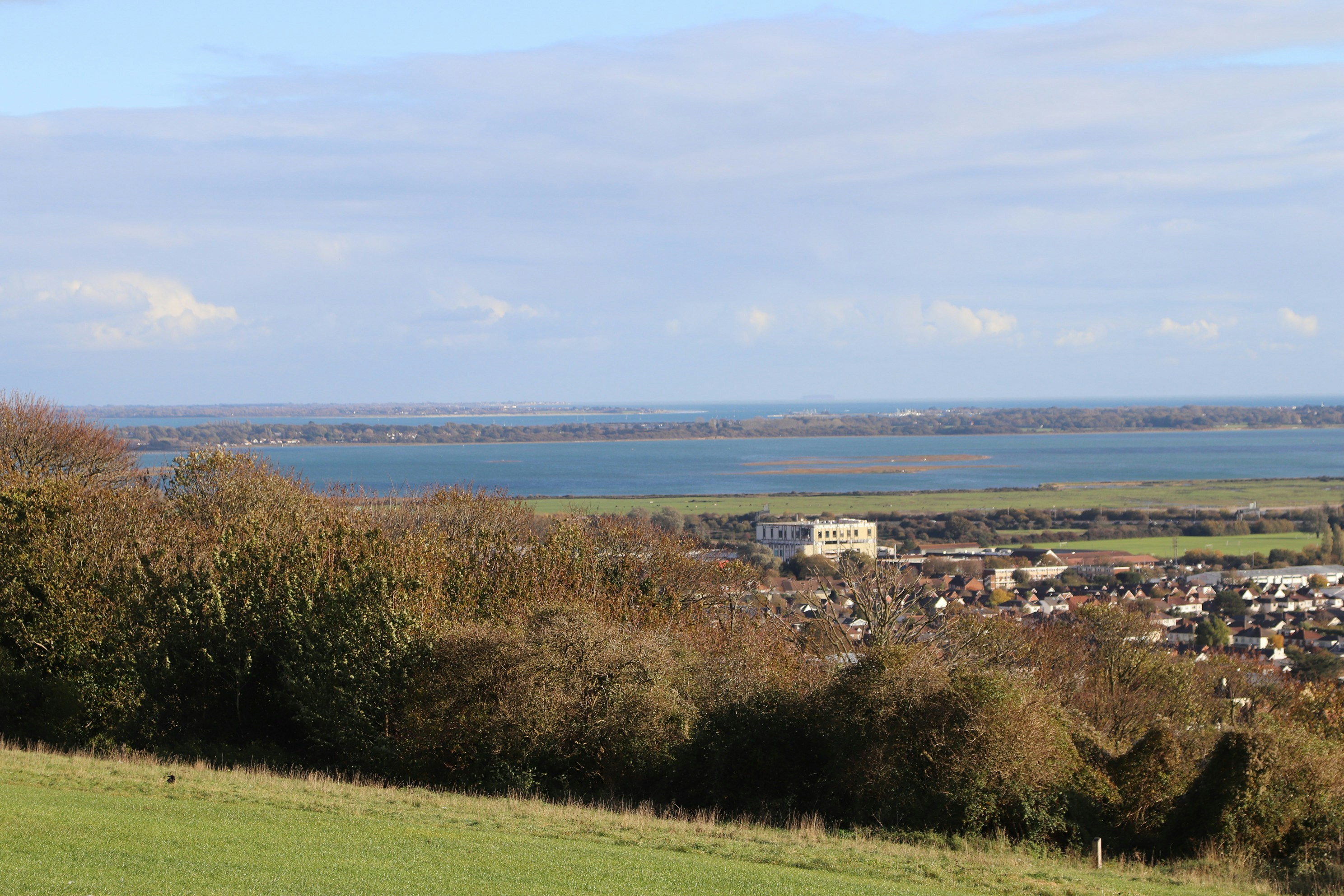 White House on the Hillside Overlooking a Calm Coastal Plain