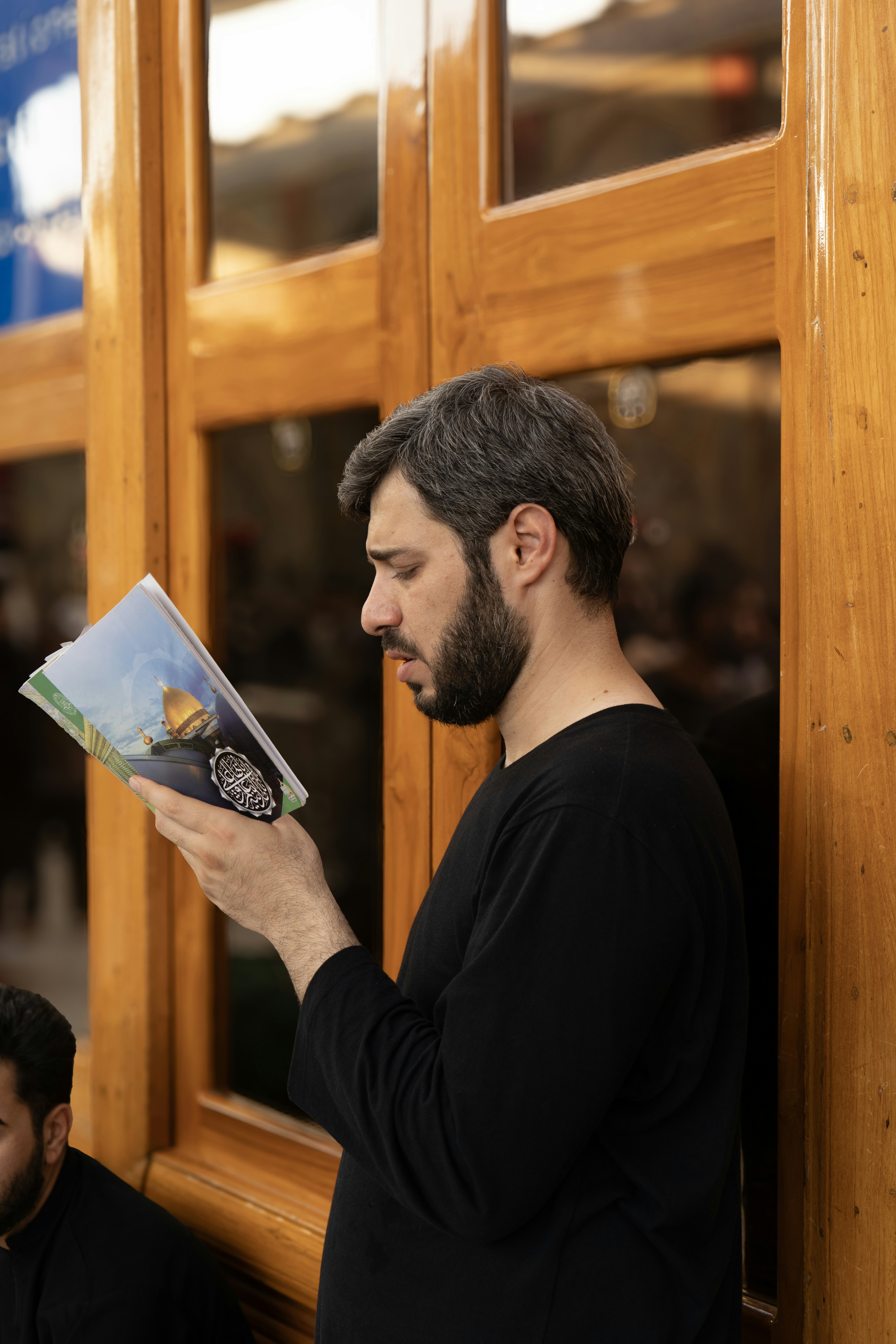 Travel Brochure in Quiet Focus by a Warm Wooden Window