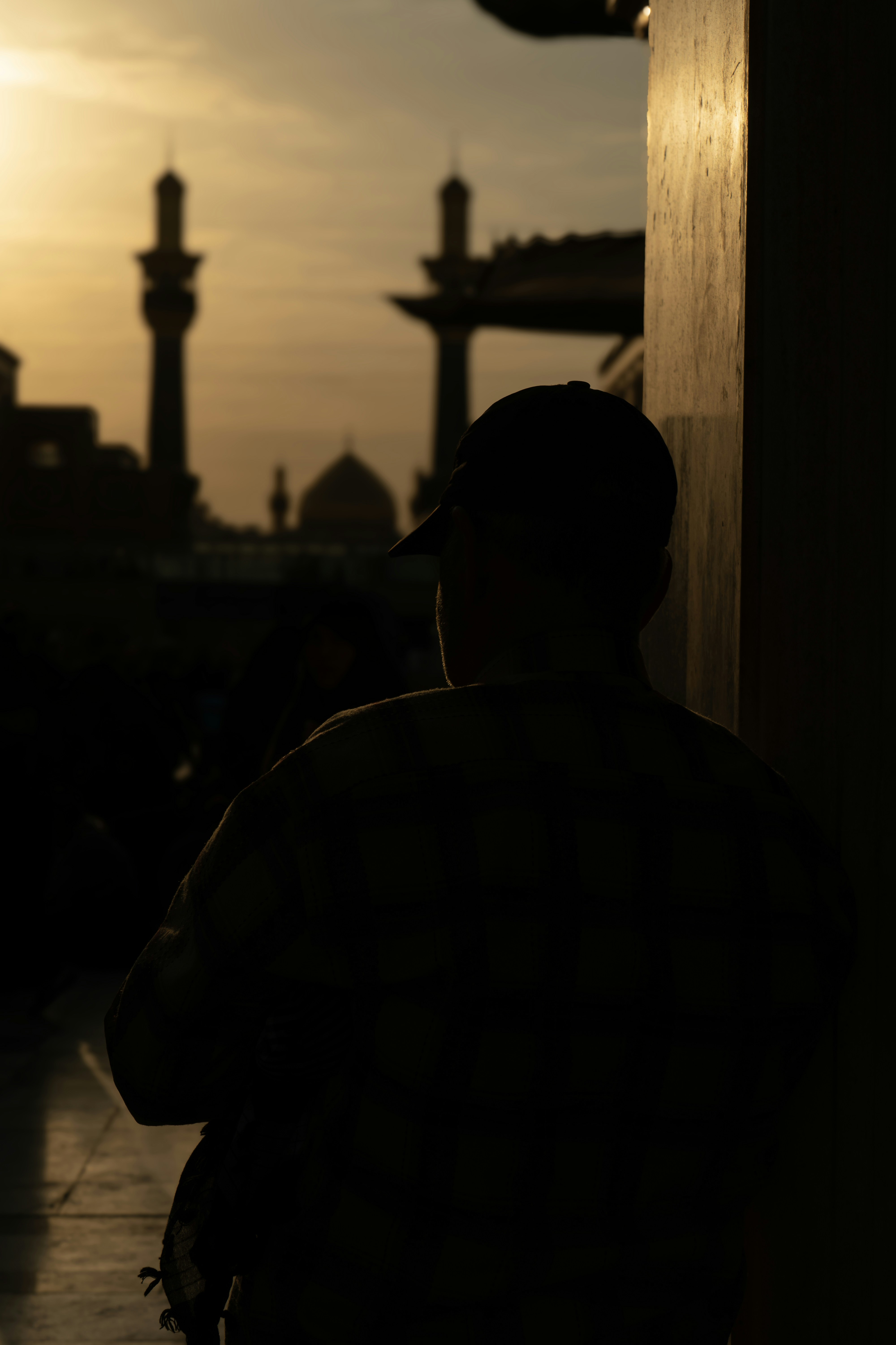 Silhouette at Dusk: A Quiet Moment by the Minarets