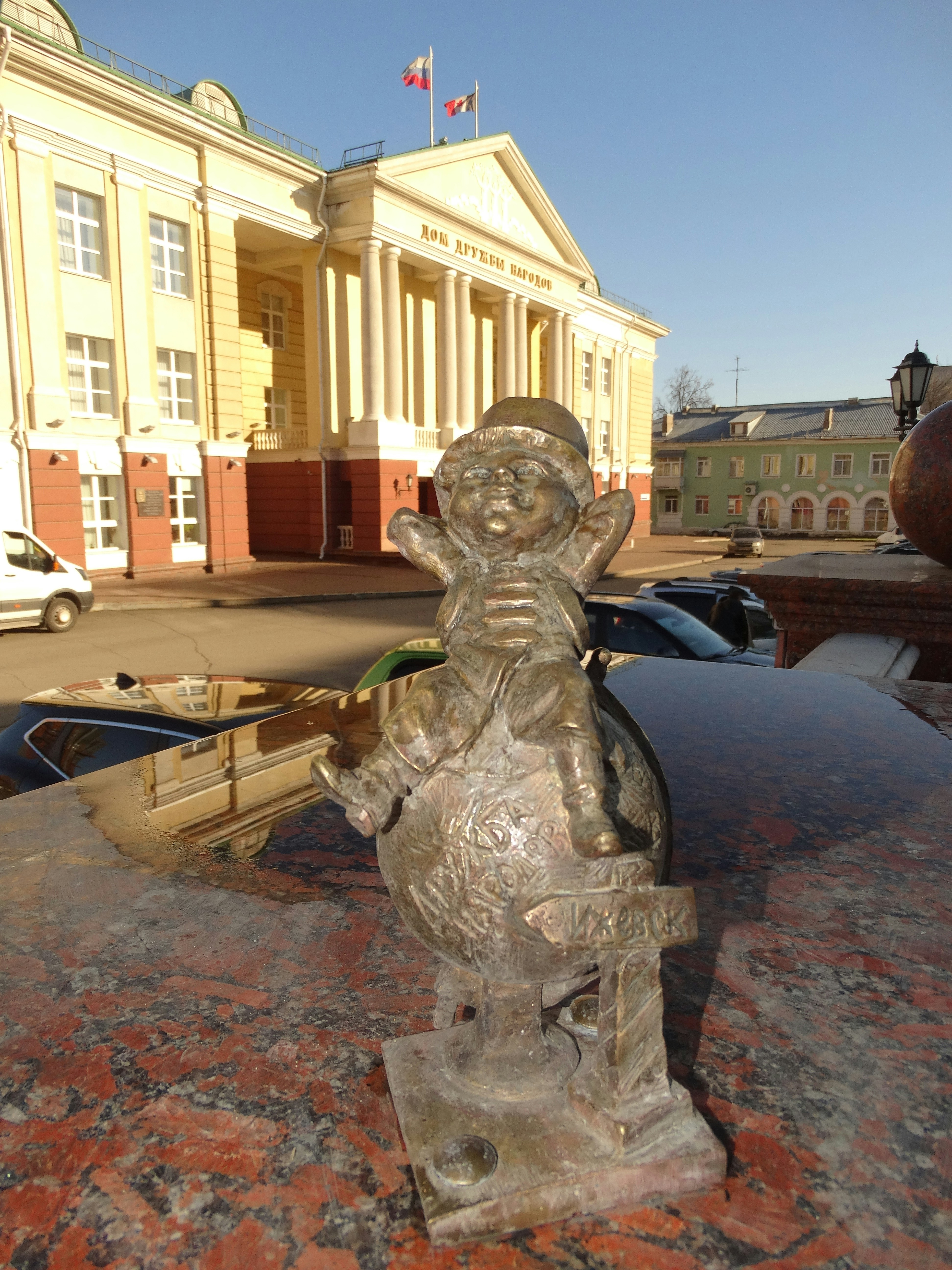 Whimsical Traveler on a Globe