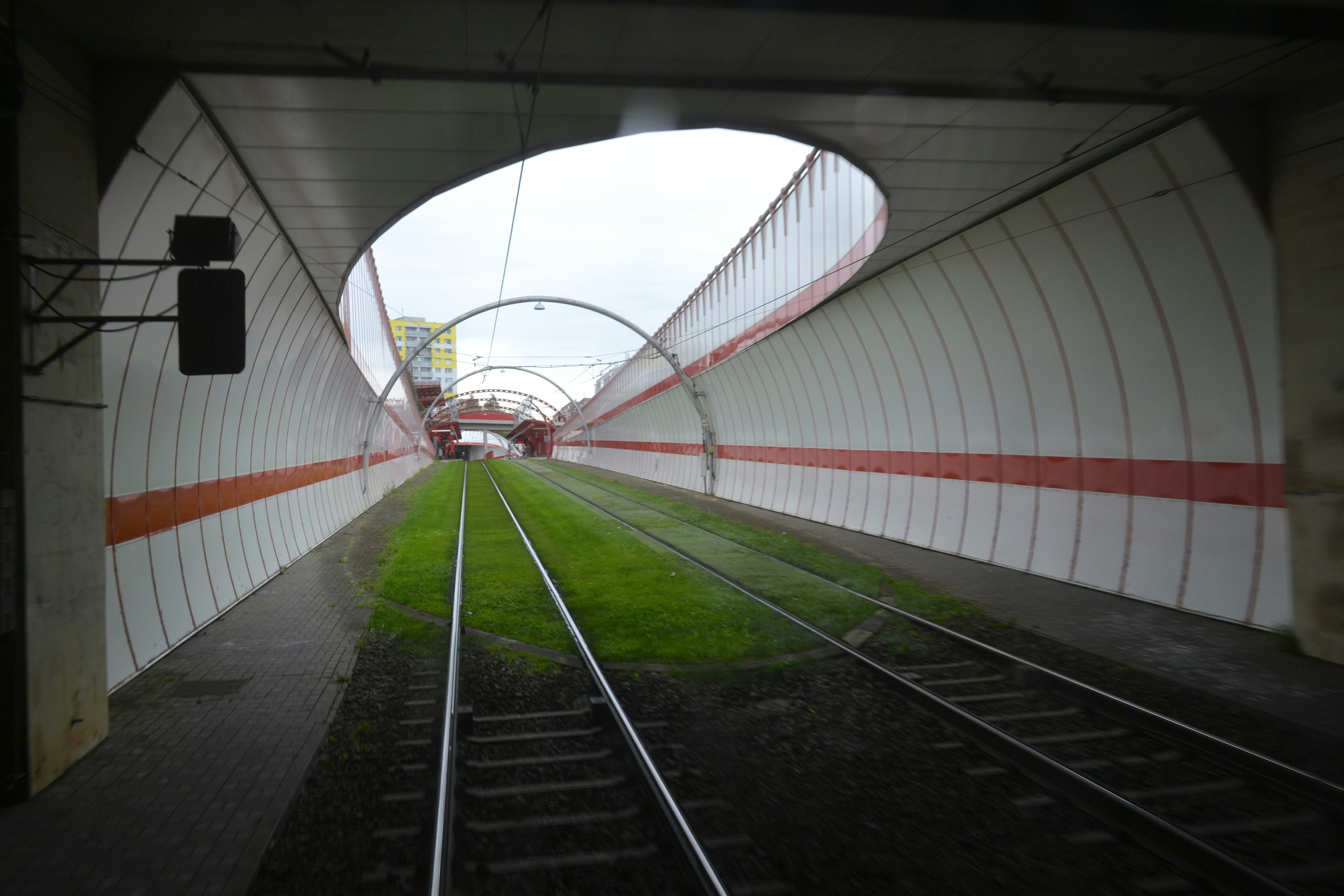 Vanishing Rails: A Curved Corridor Toward the Distant Light