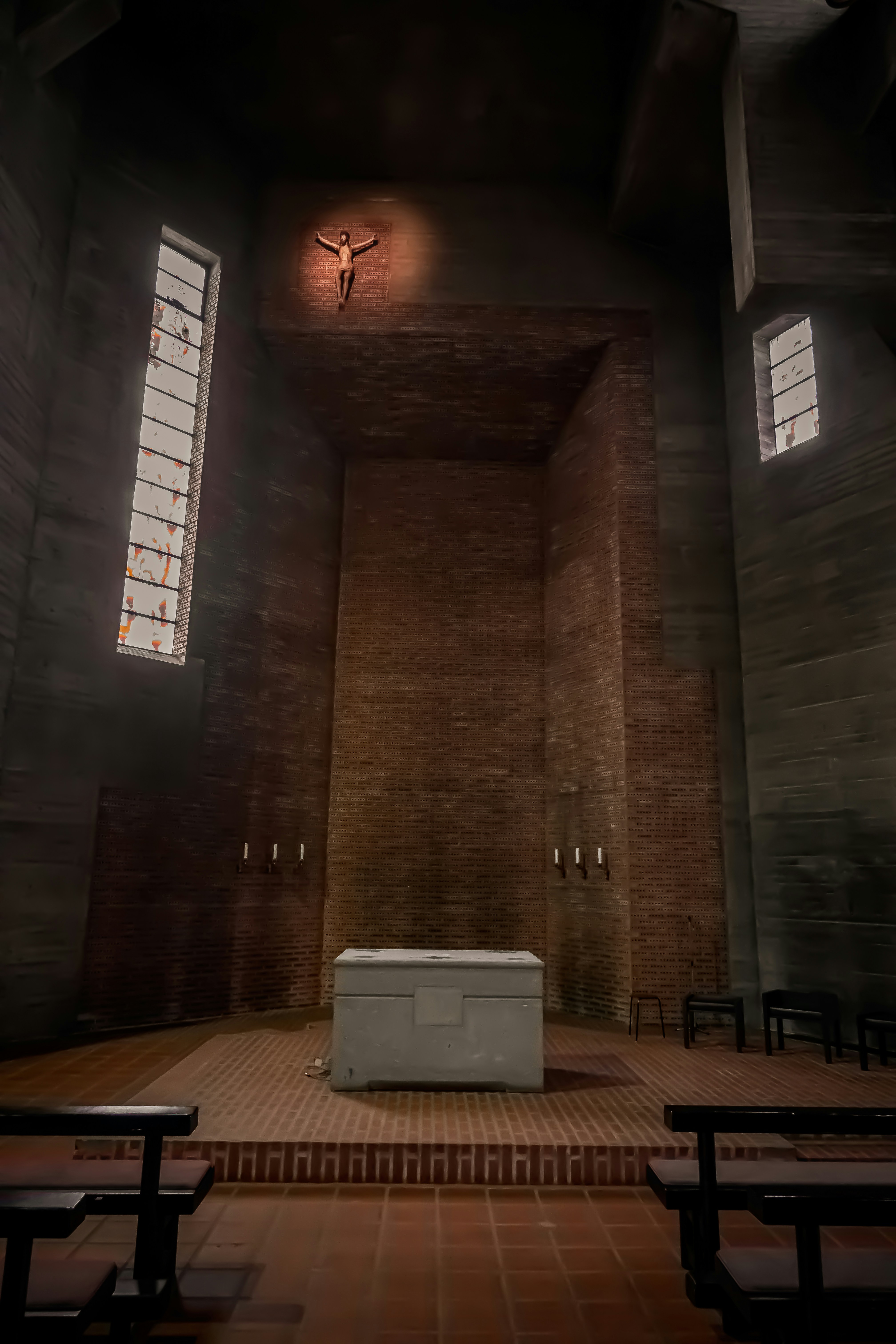 Crucifix at the Apex: Brick Chapel Lit by Narrow Windows
