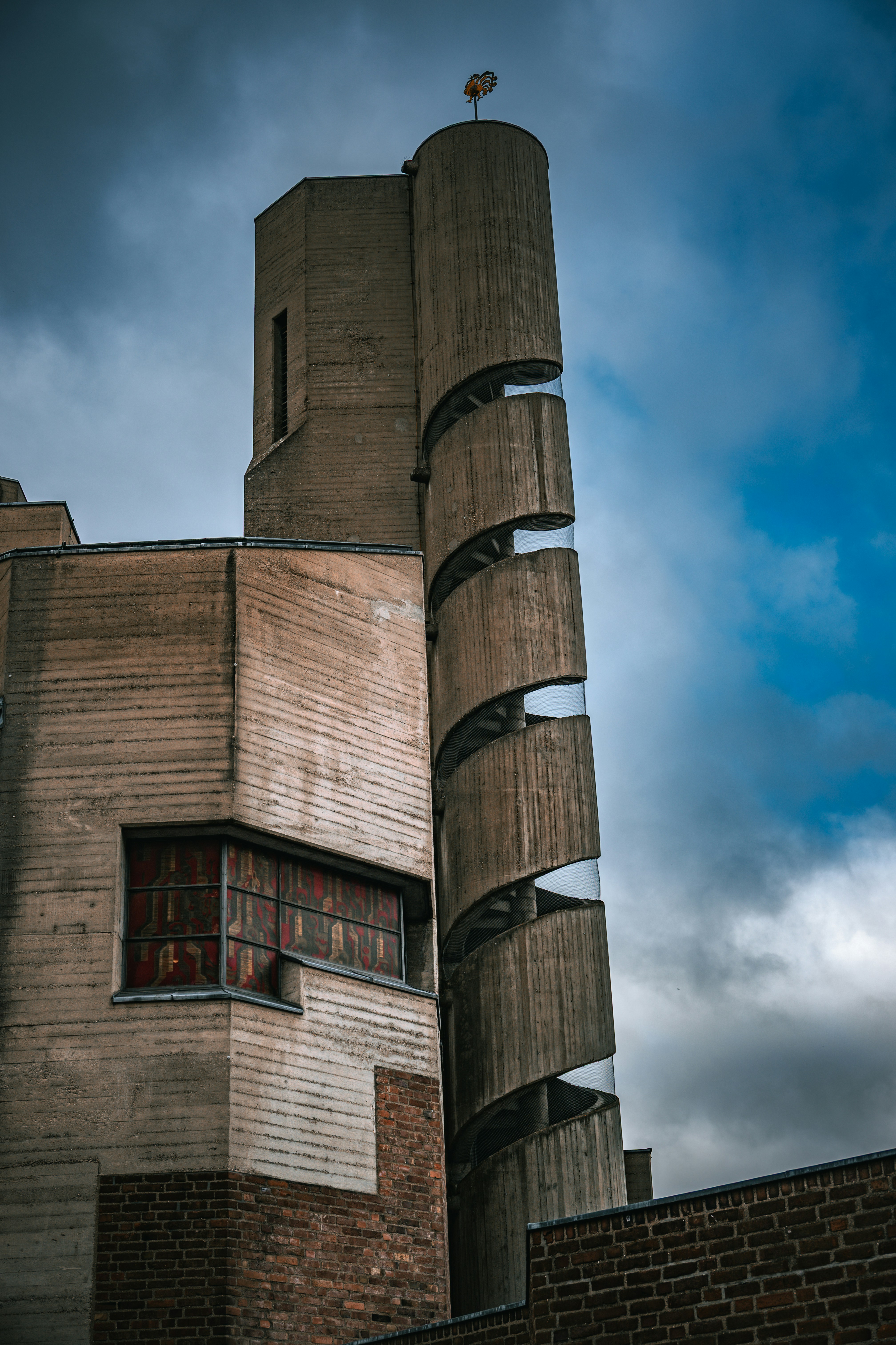 Concrete Helix: Spiral Stair Tower Rising from a Brutalist Monolith