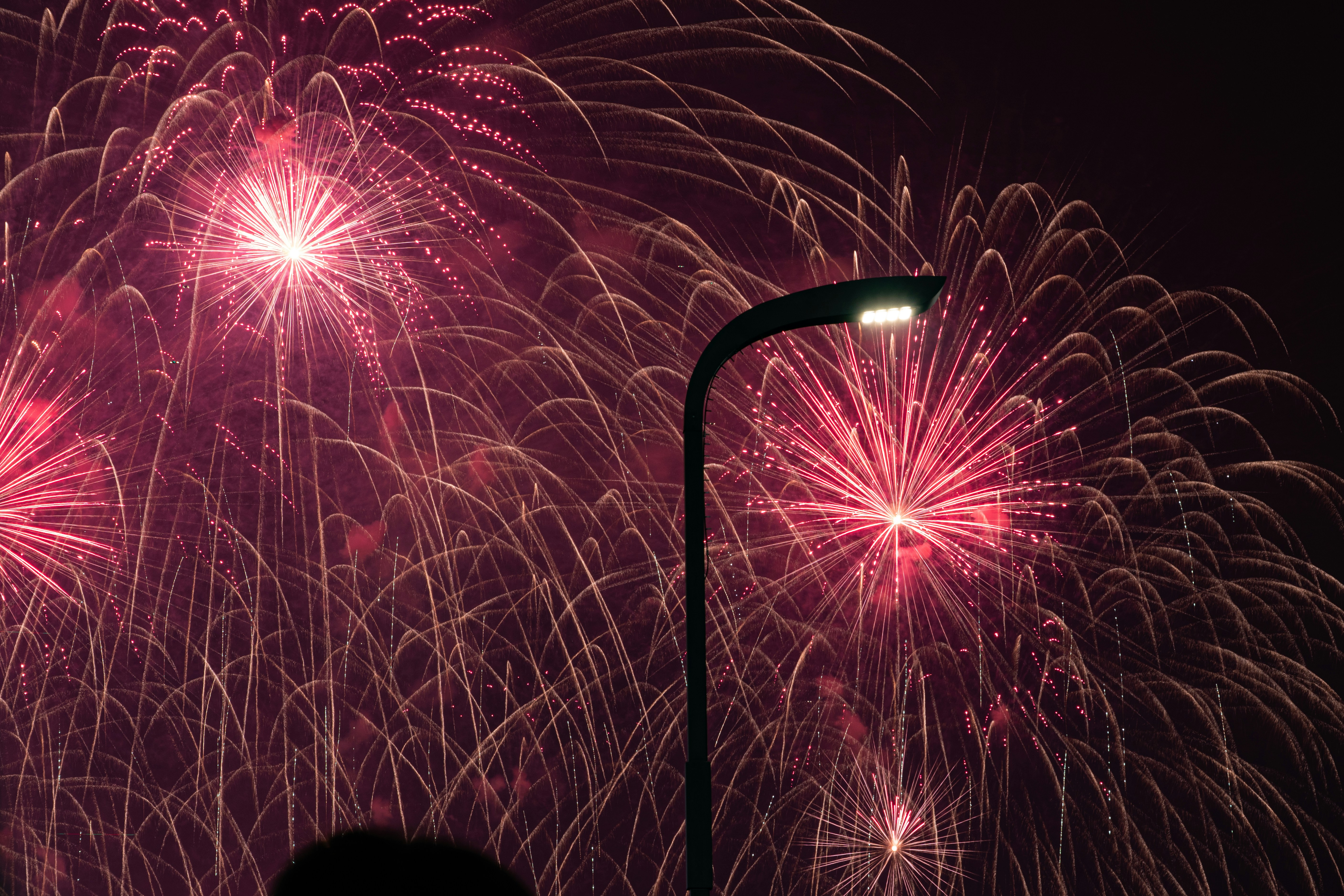 Crimson Bursts Behind the Streetlamp