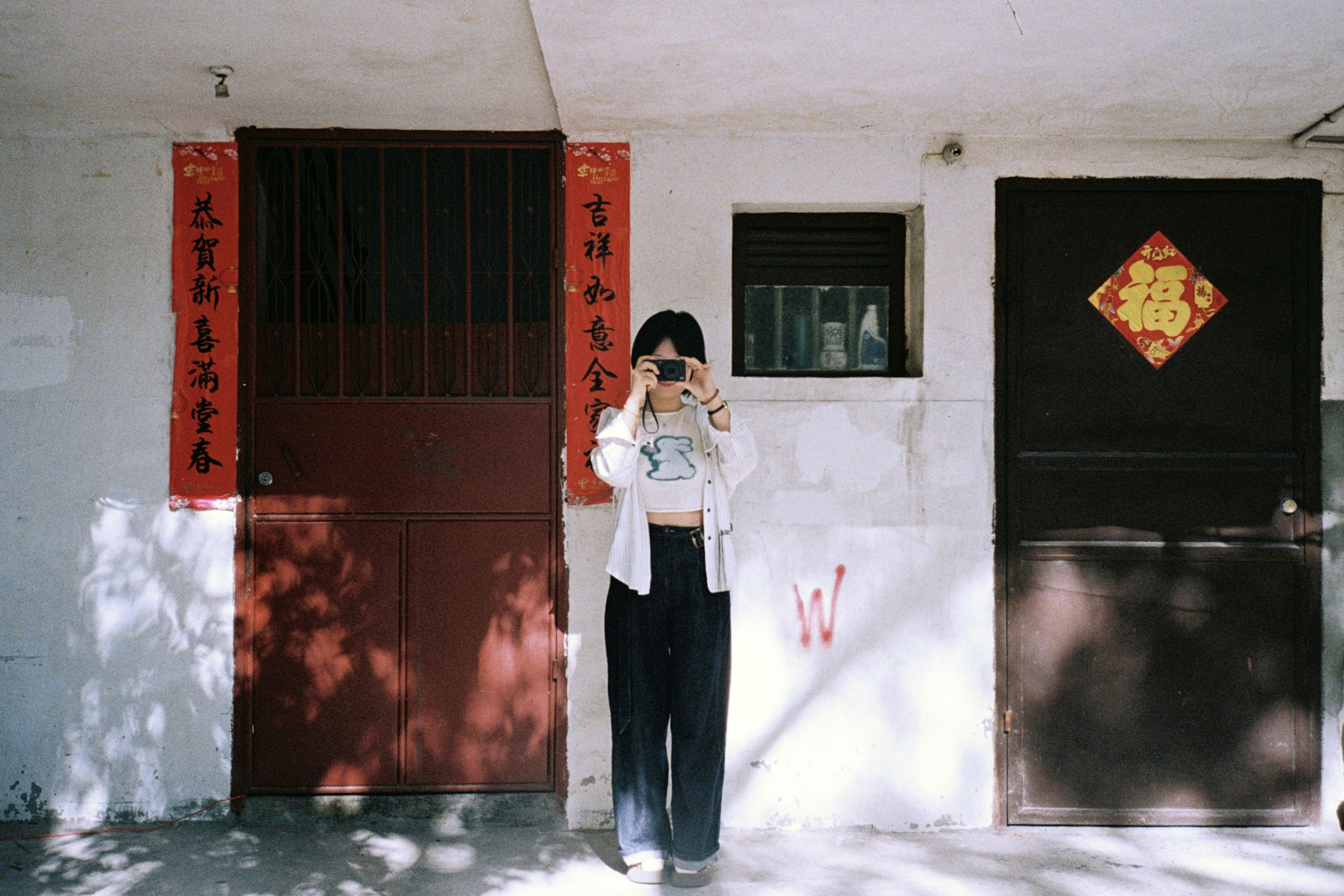 Woman taking a picture with a camera.