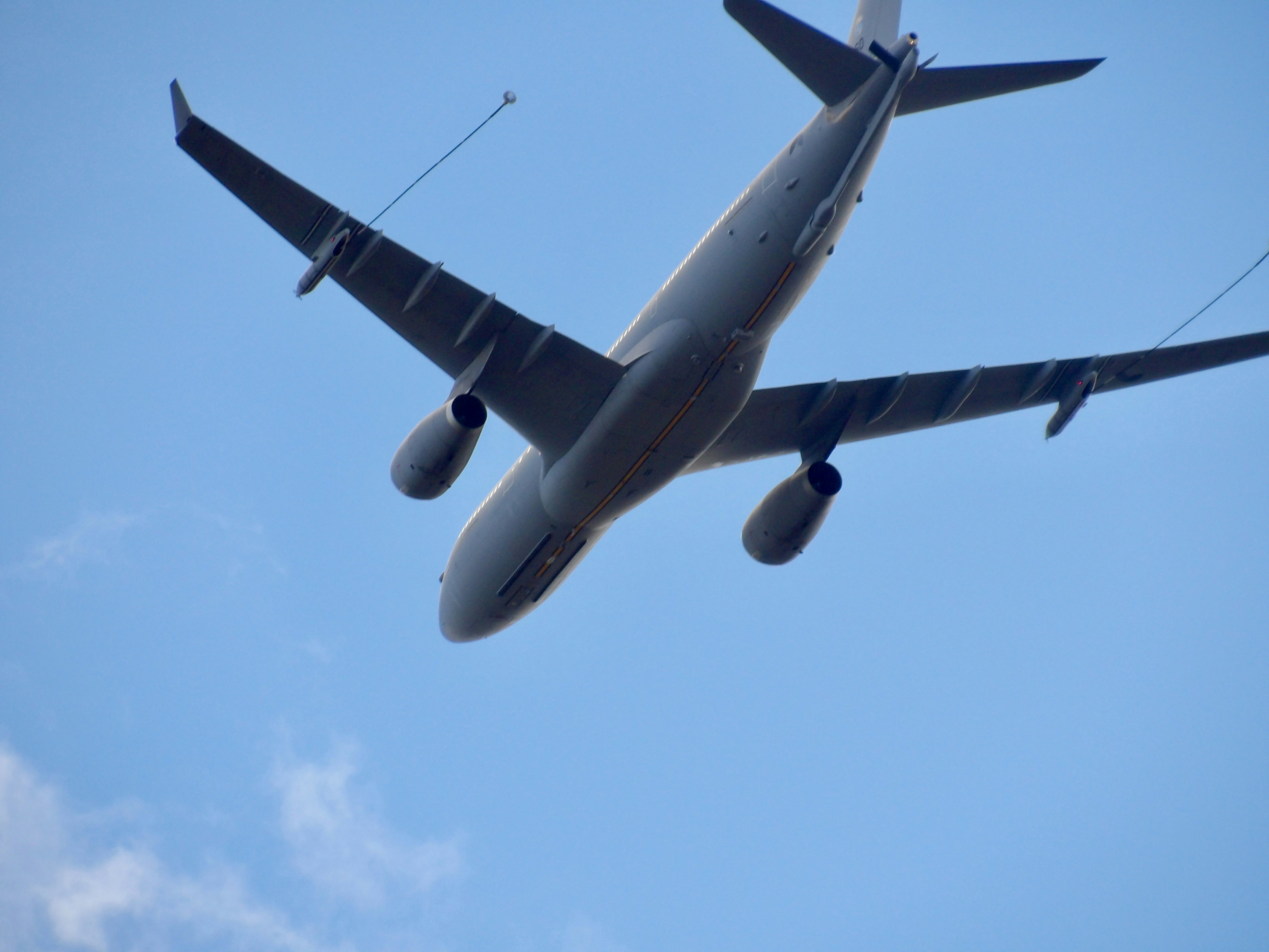 Commercial airplane soaring through a clear blue sky, showcasing its aerodynamic design and powerful engines.