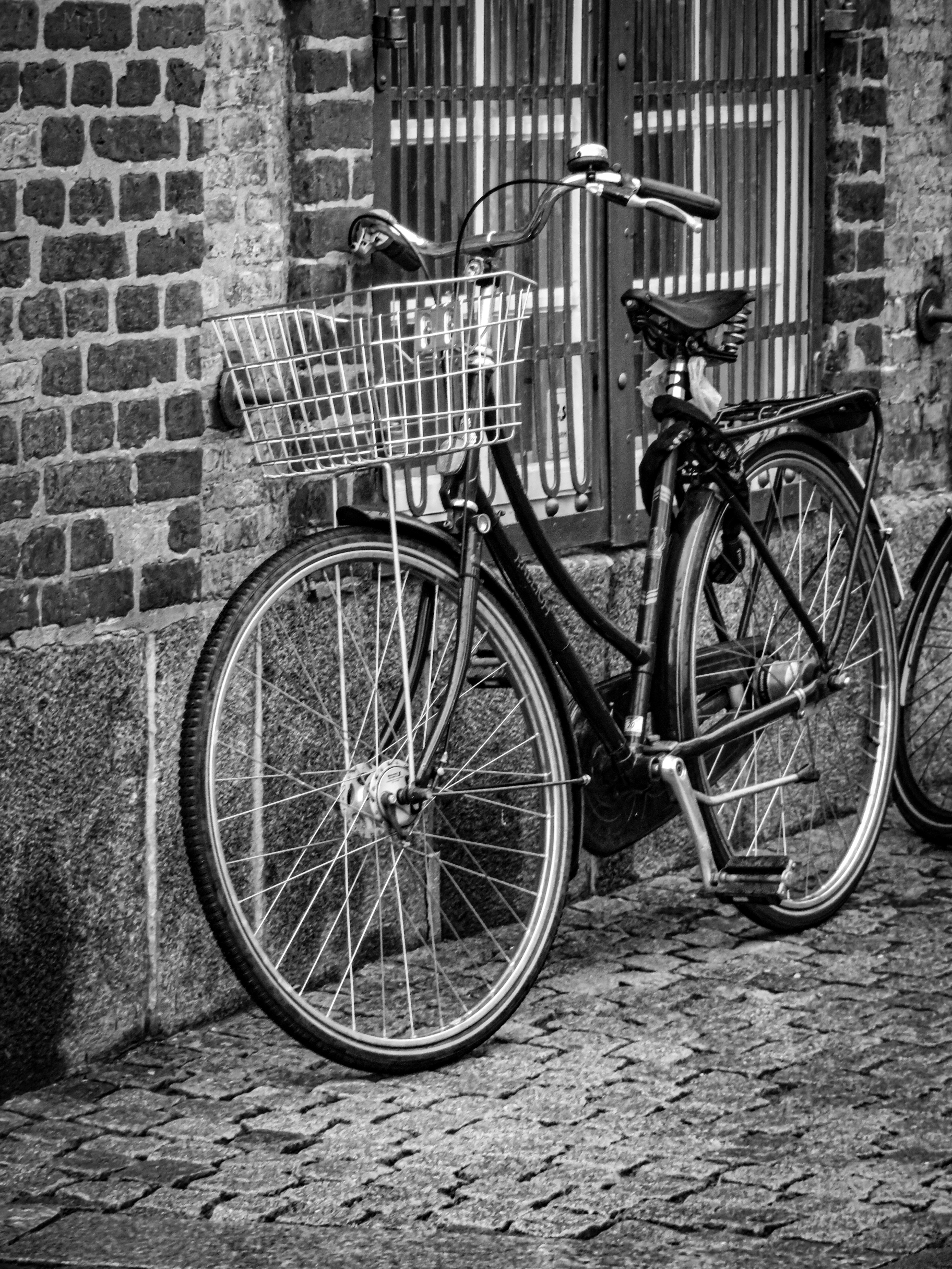 A vintage bicycle leans against a brick wall. photo – Free Travel Image ...