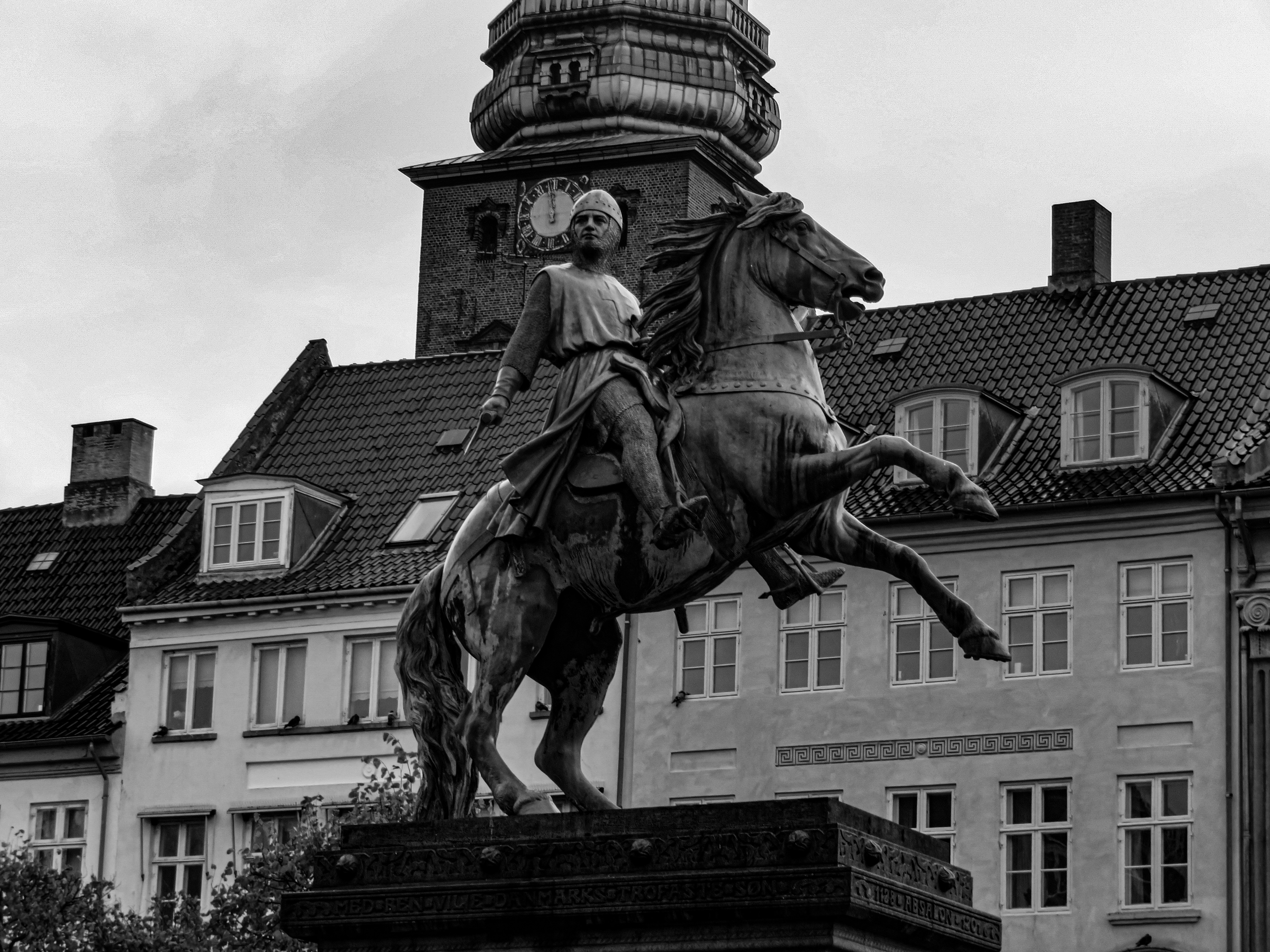 Equestrian statue in front of historic buildings