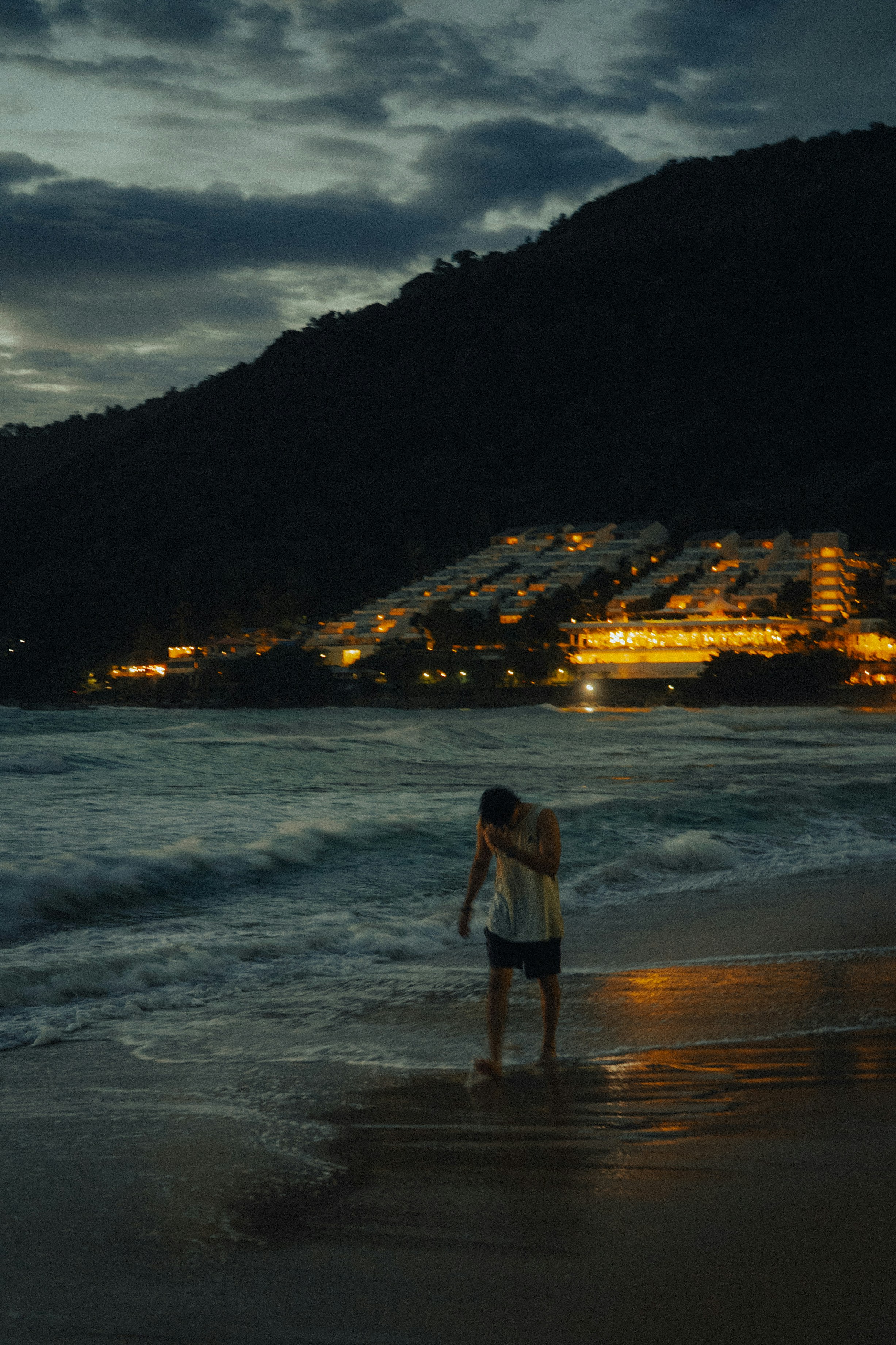 Low Tide, Neon Village: A Lone Figure on Wrinkled Shore