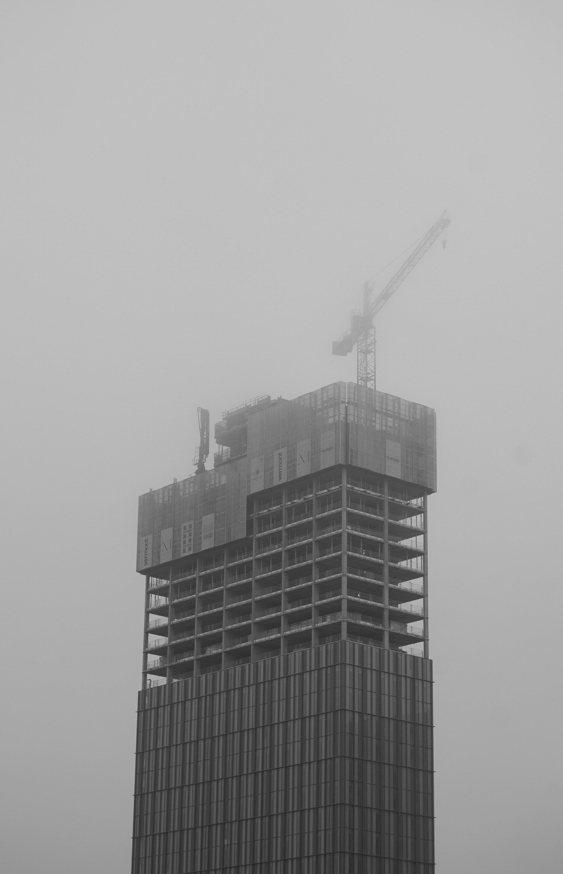 Skyscraper under construction in foggy weather