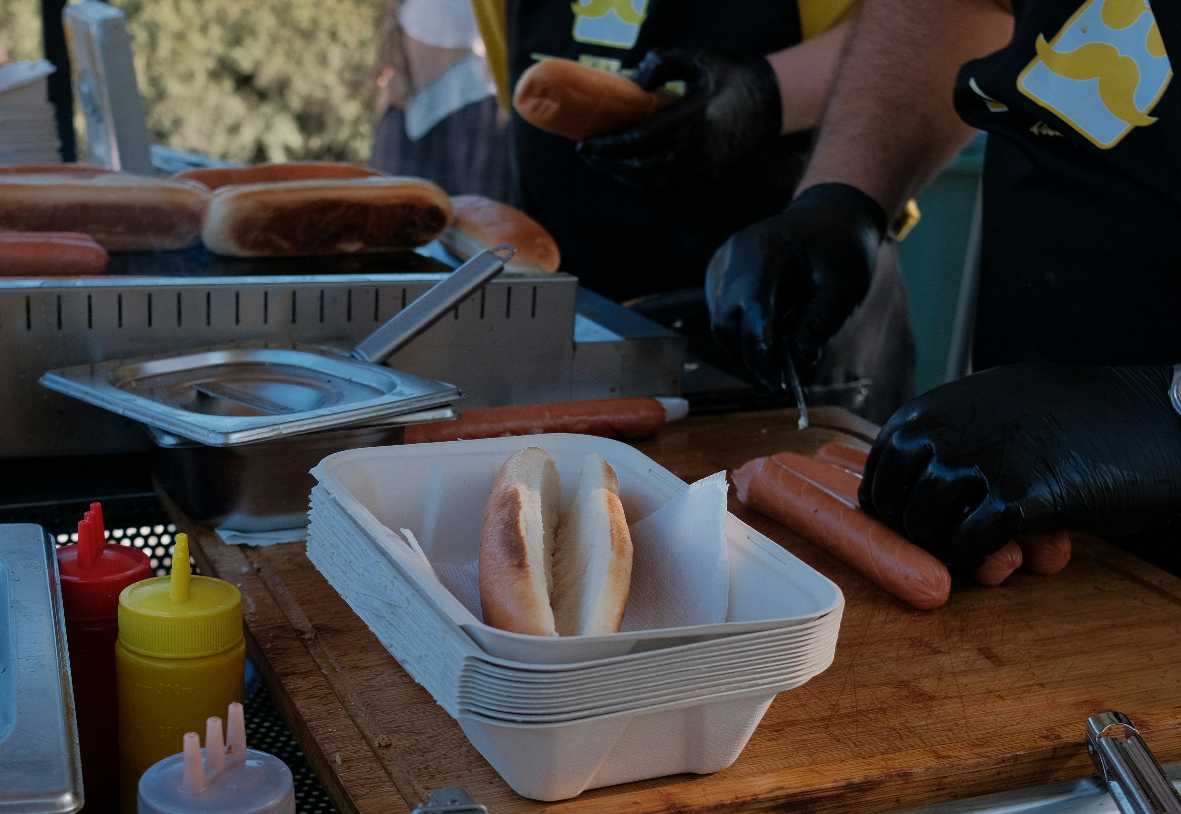 Hot dogs being prepared at a street food stand.