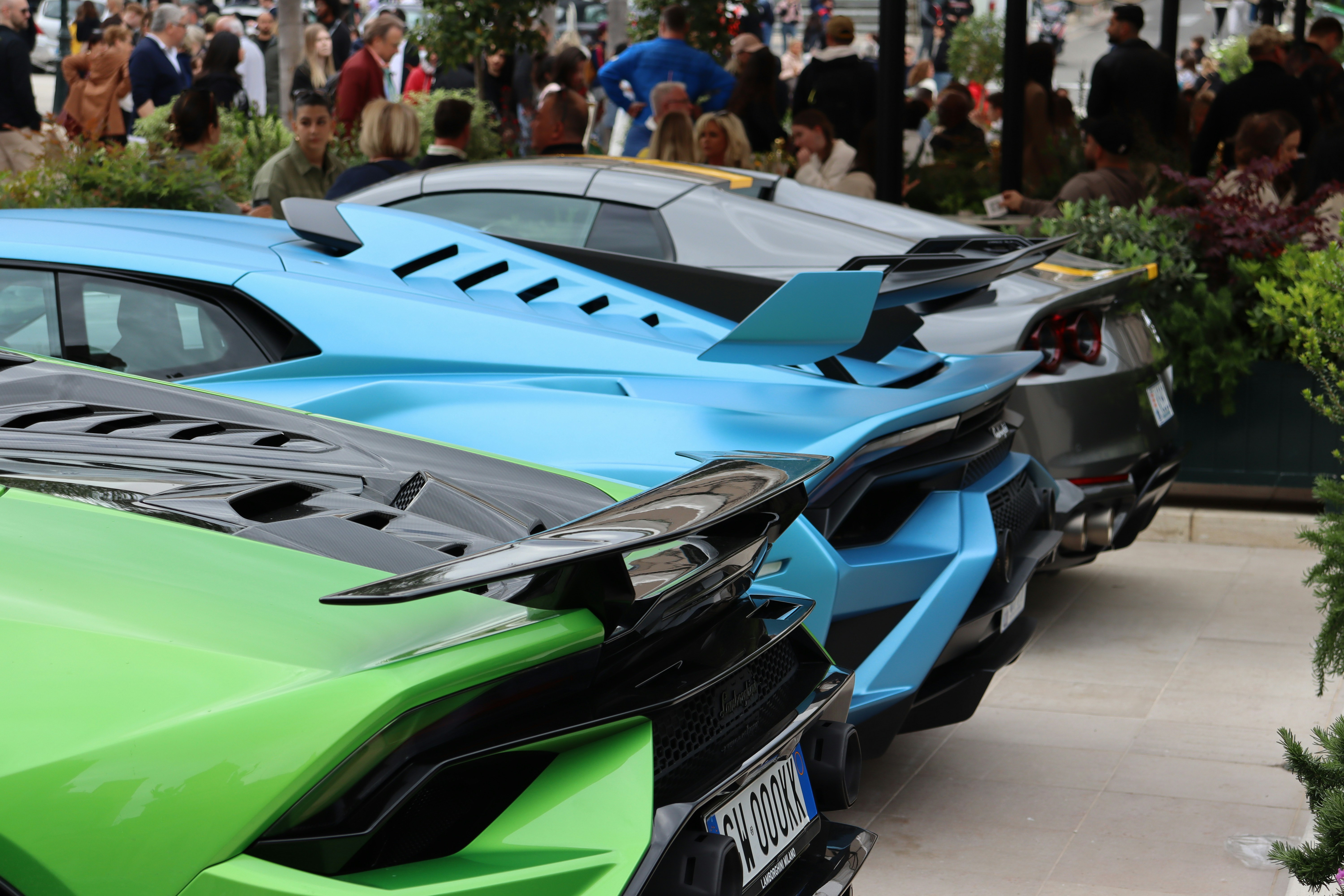 Supercars in Monaco | Three colorful sports cars parked in a row.