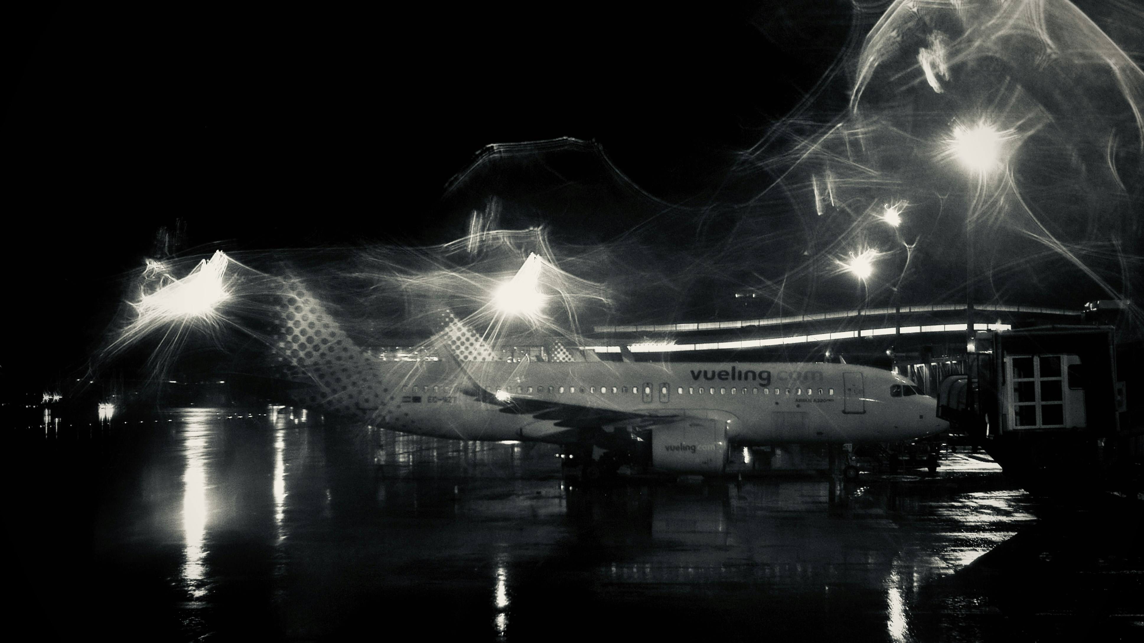 Airplane at night with bright lights and reflections