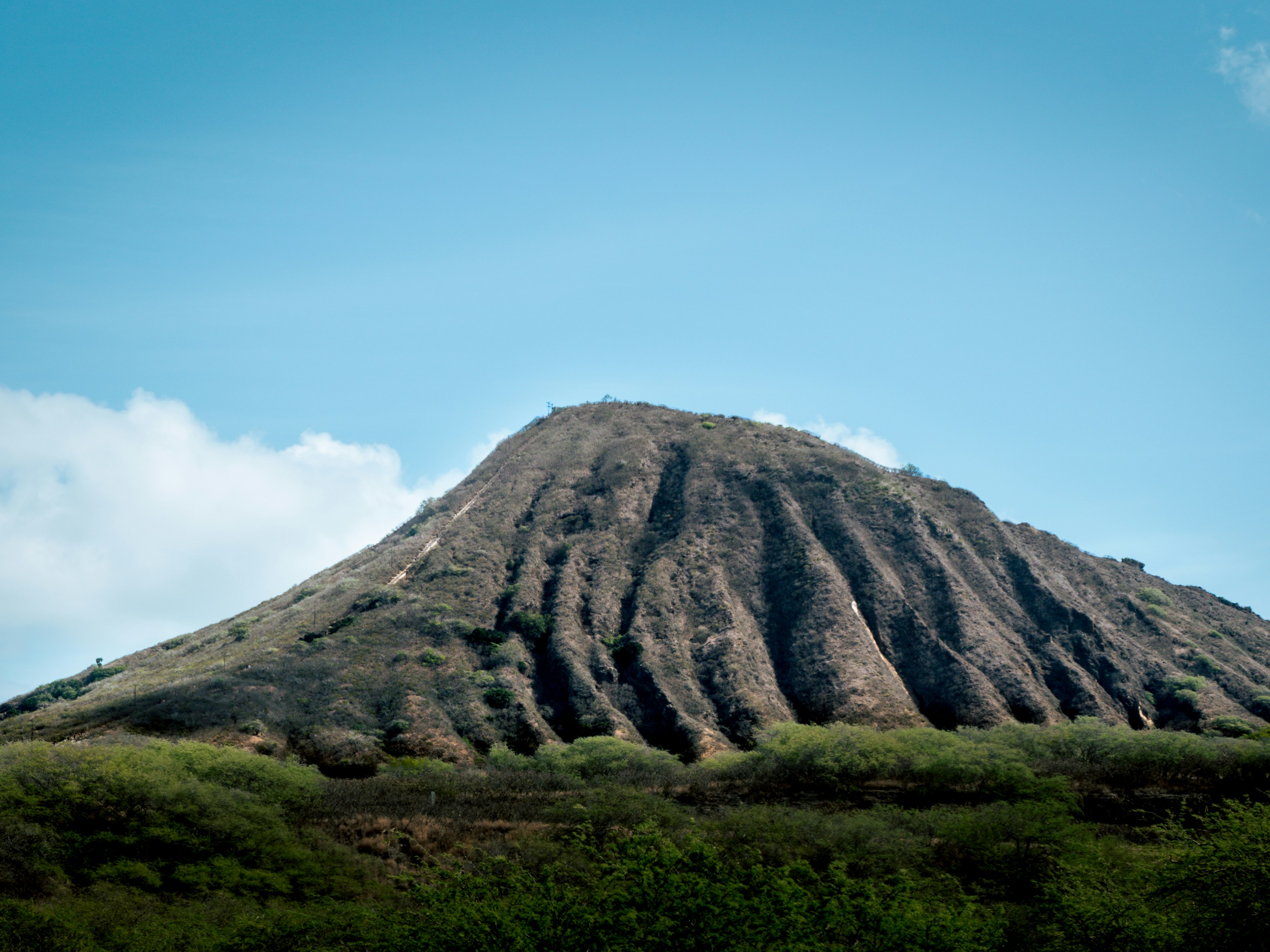 Volcanic cone with lush green vegetation below