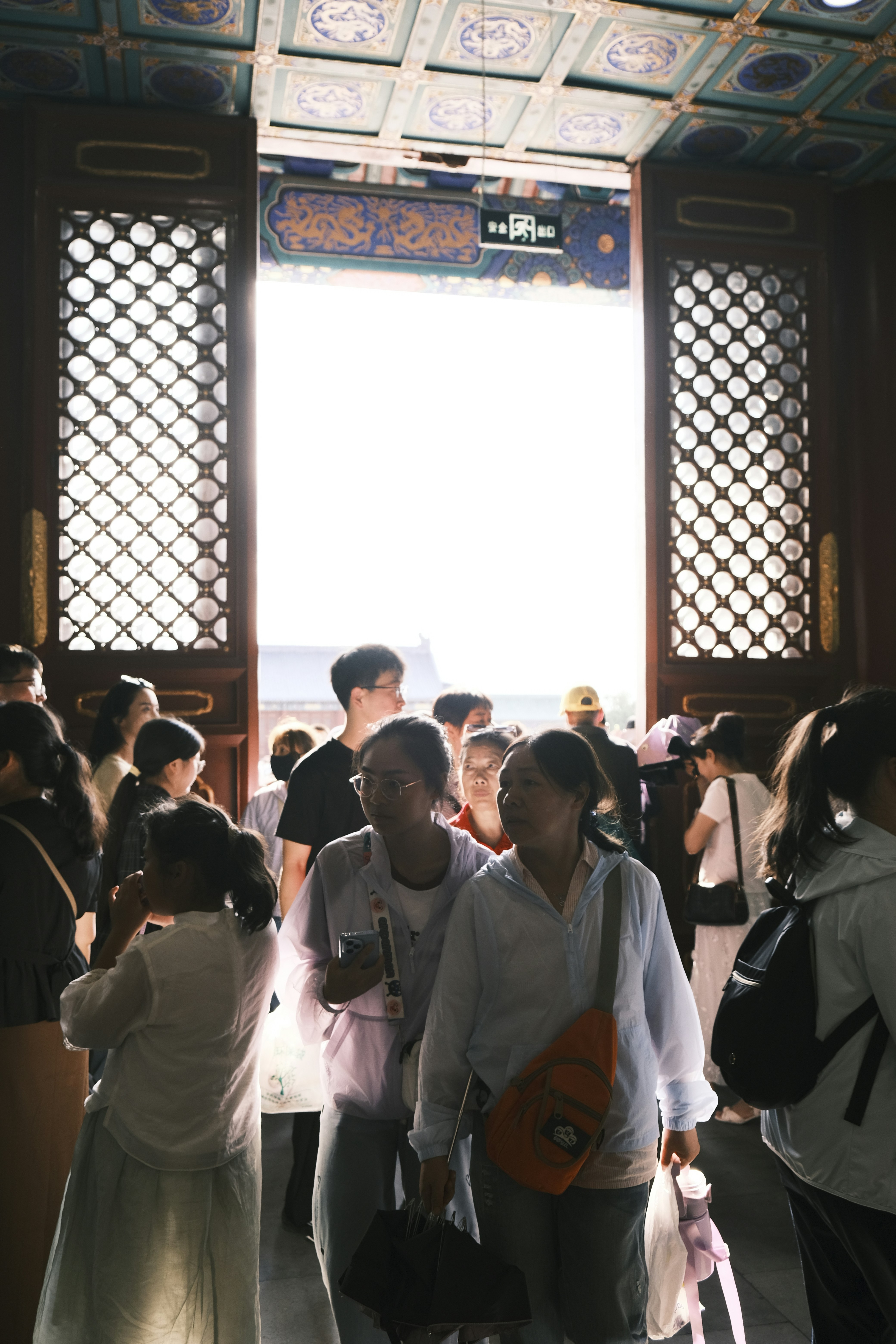 Sunlit Threshold: Crowds at an Ornate Temple Gate