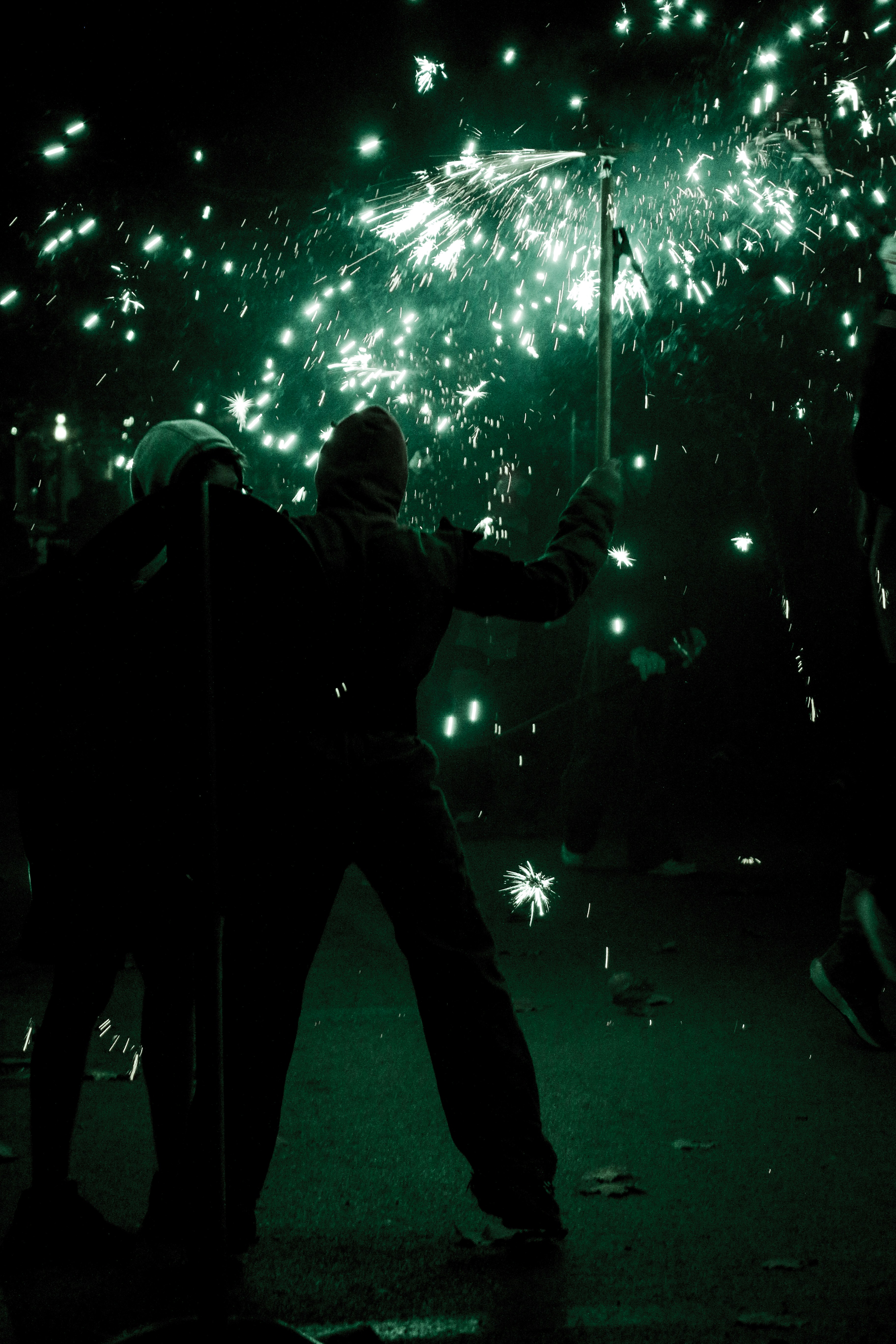 Emerald Sparks Convergence: Night Street Silhouettes in Motion