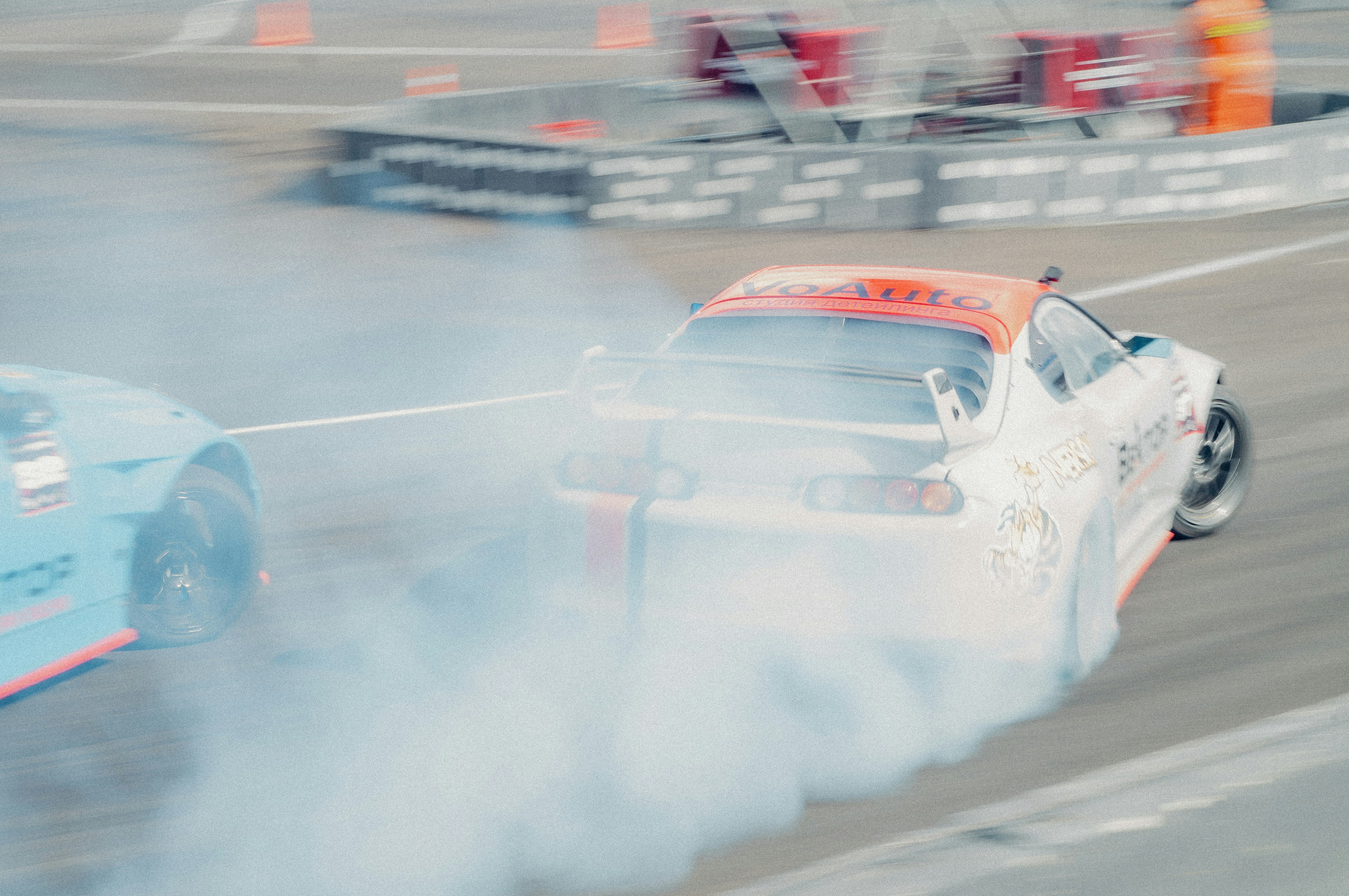 Two cars drifting with smoke on track