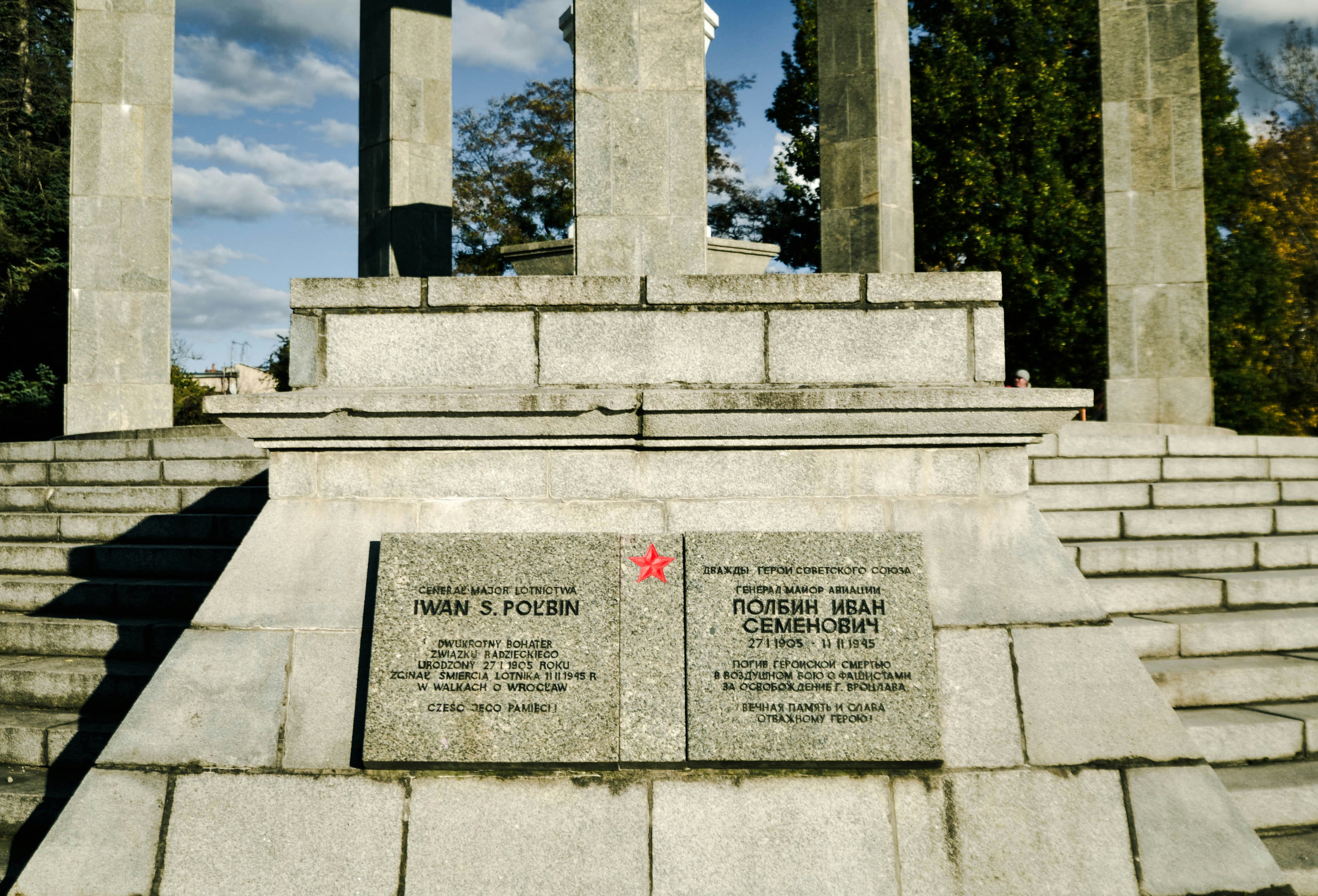 Stone monument with inscriptions and red star