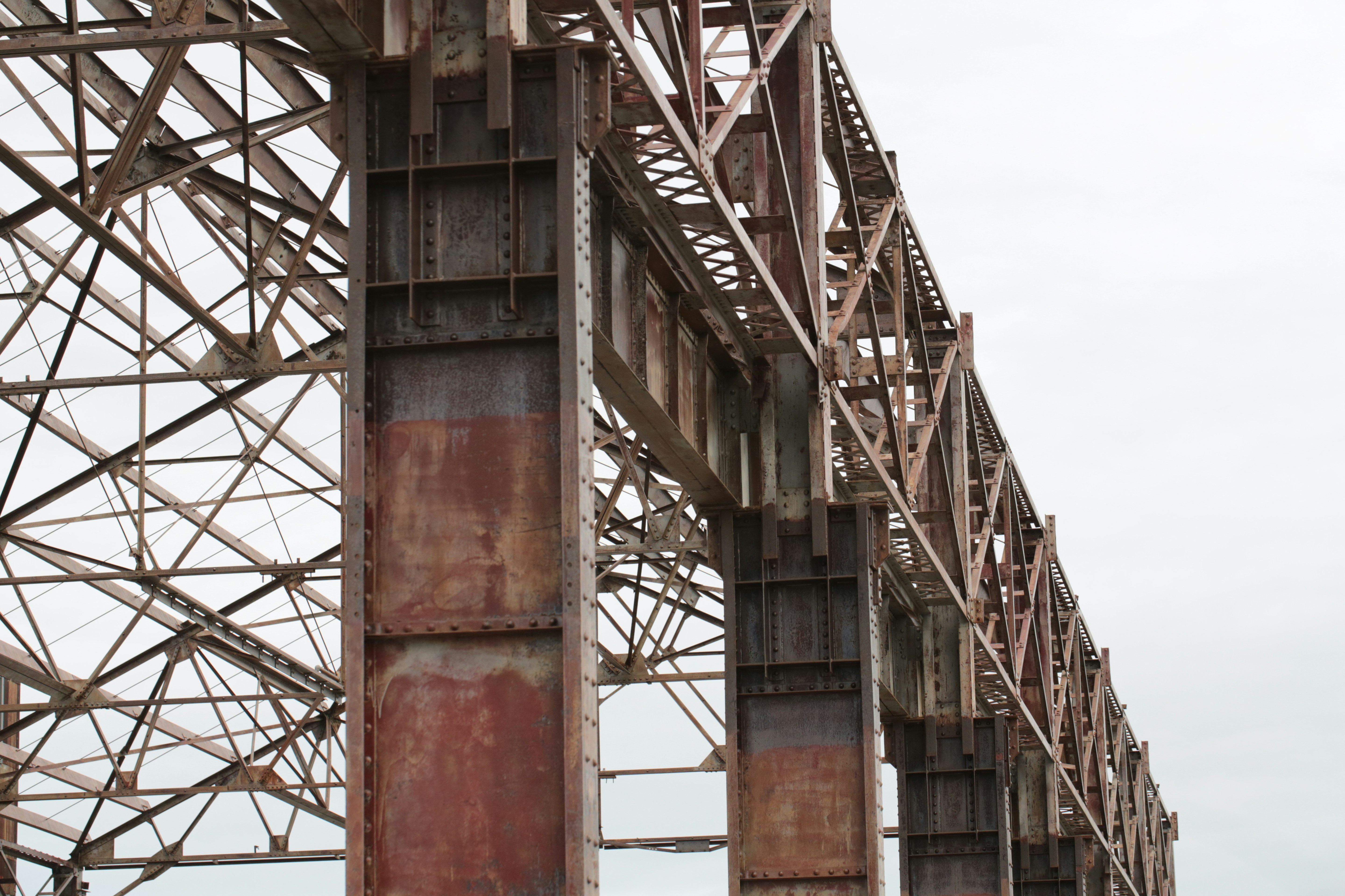 Weathered industrial steel structure against a cloudy sky