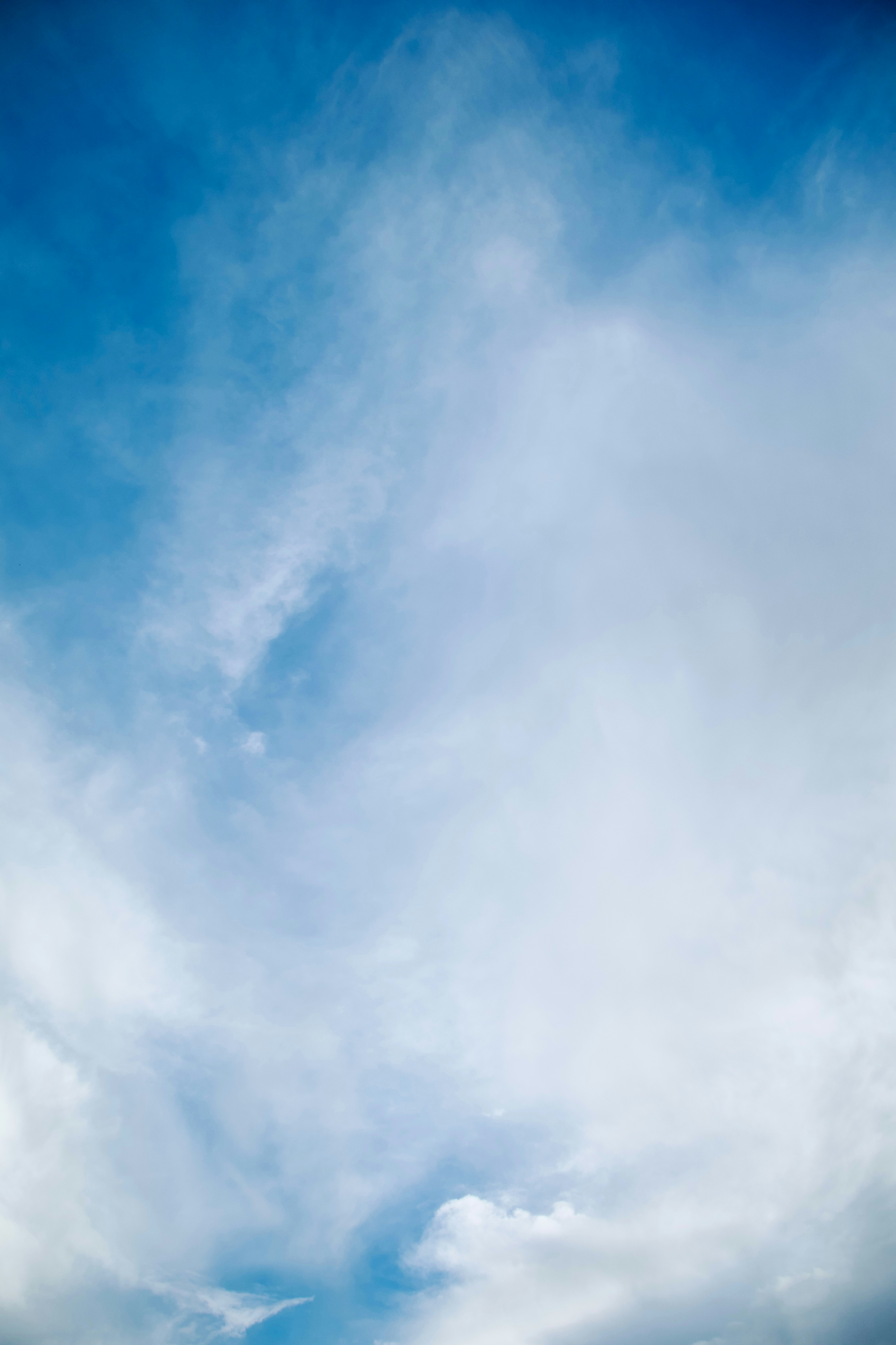 Wispy clouds against a bright blue sky