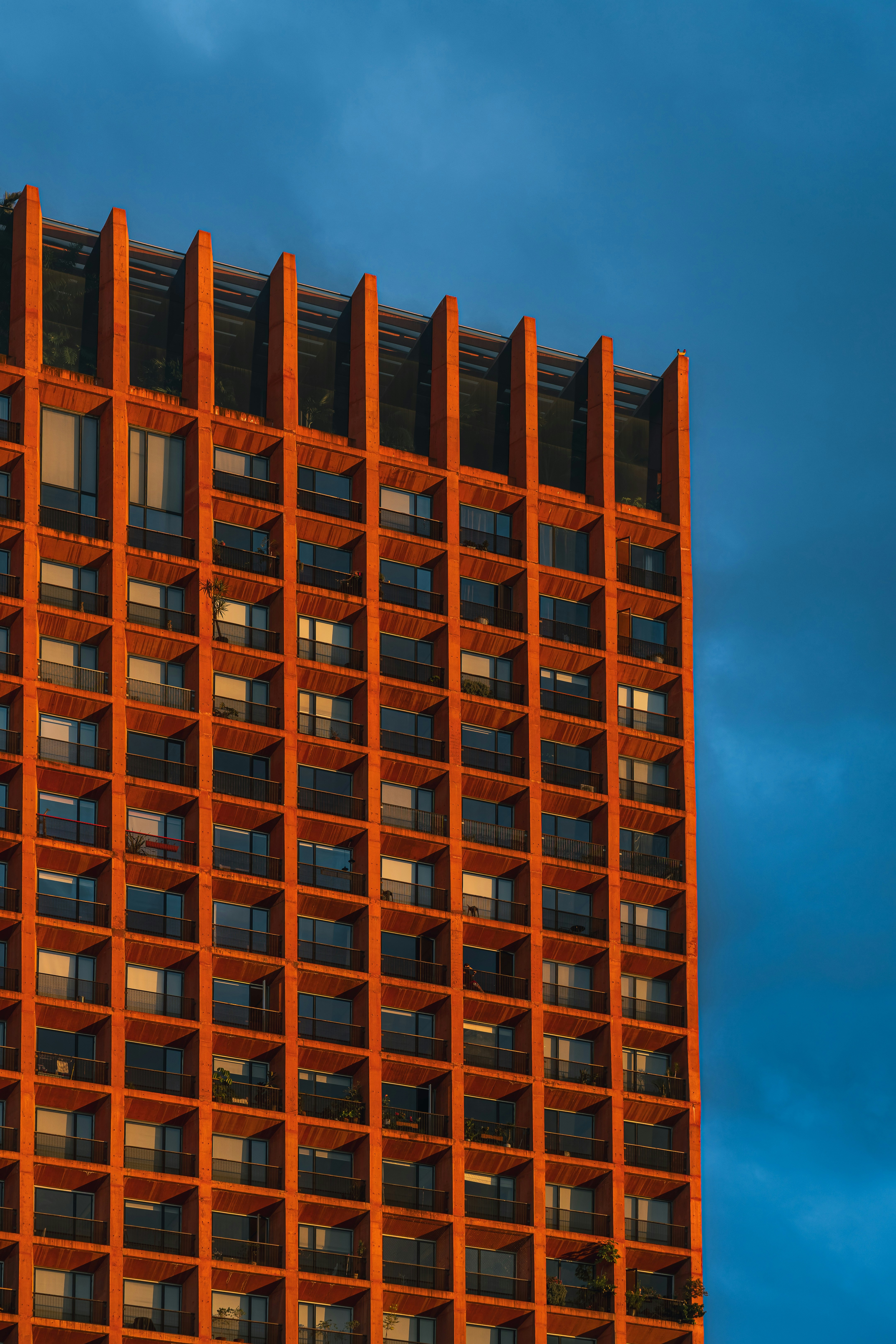 Orange building facade against a dramatic blue sky