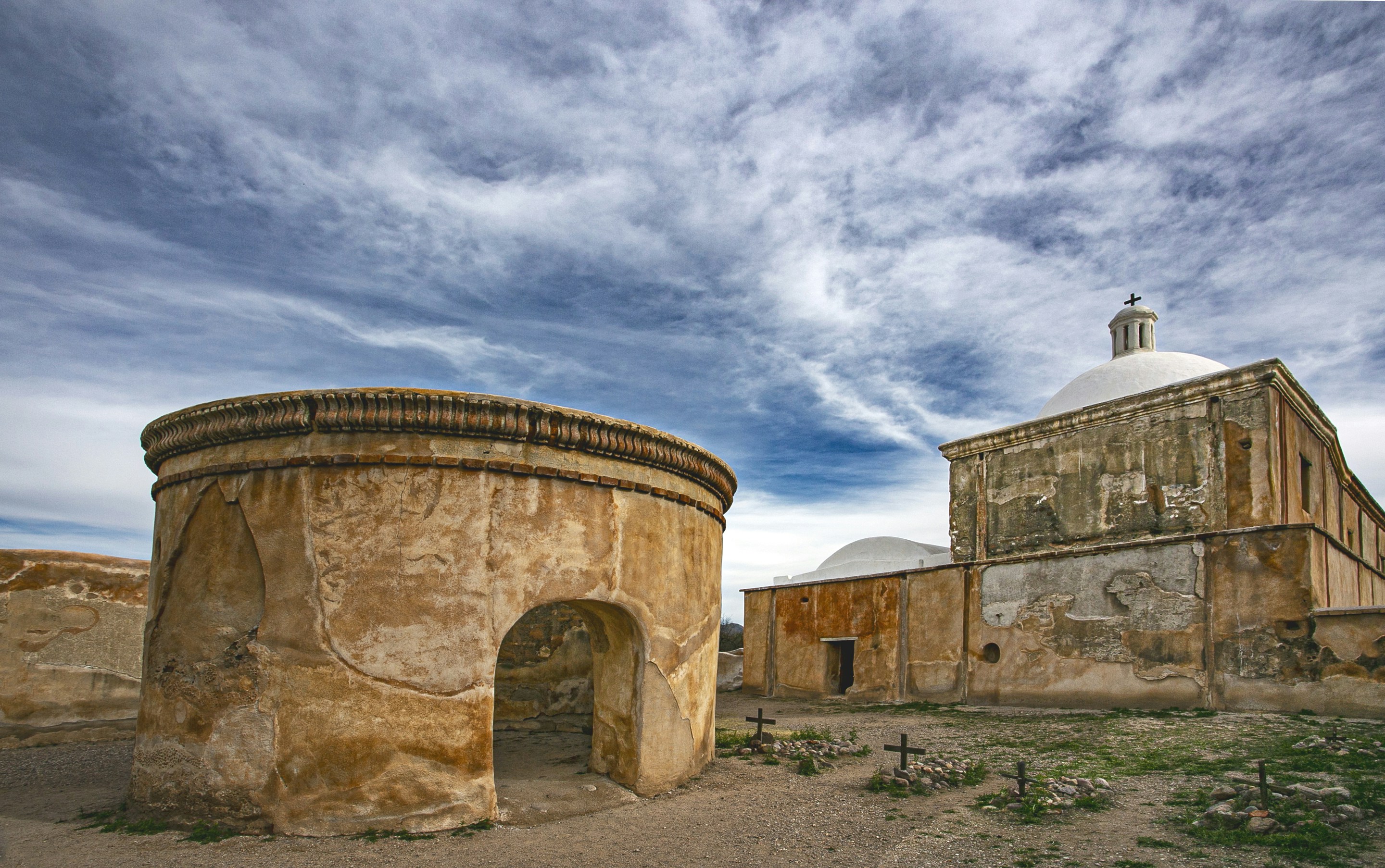 Tumacacori National Monument | Ancient adobe ruins under a dramatic cloudy sky