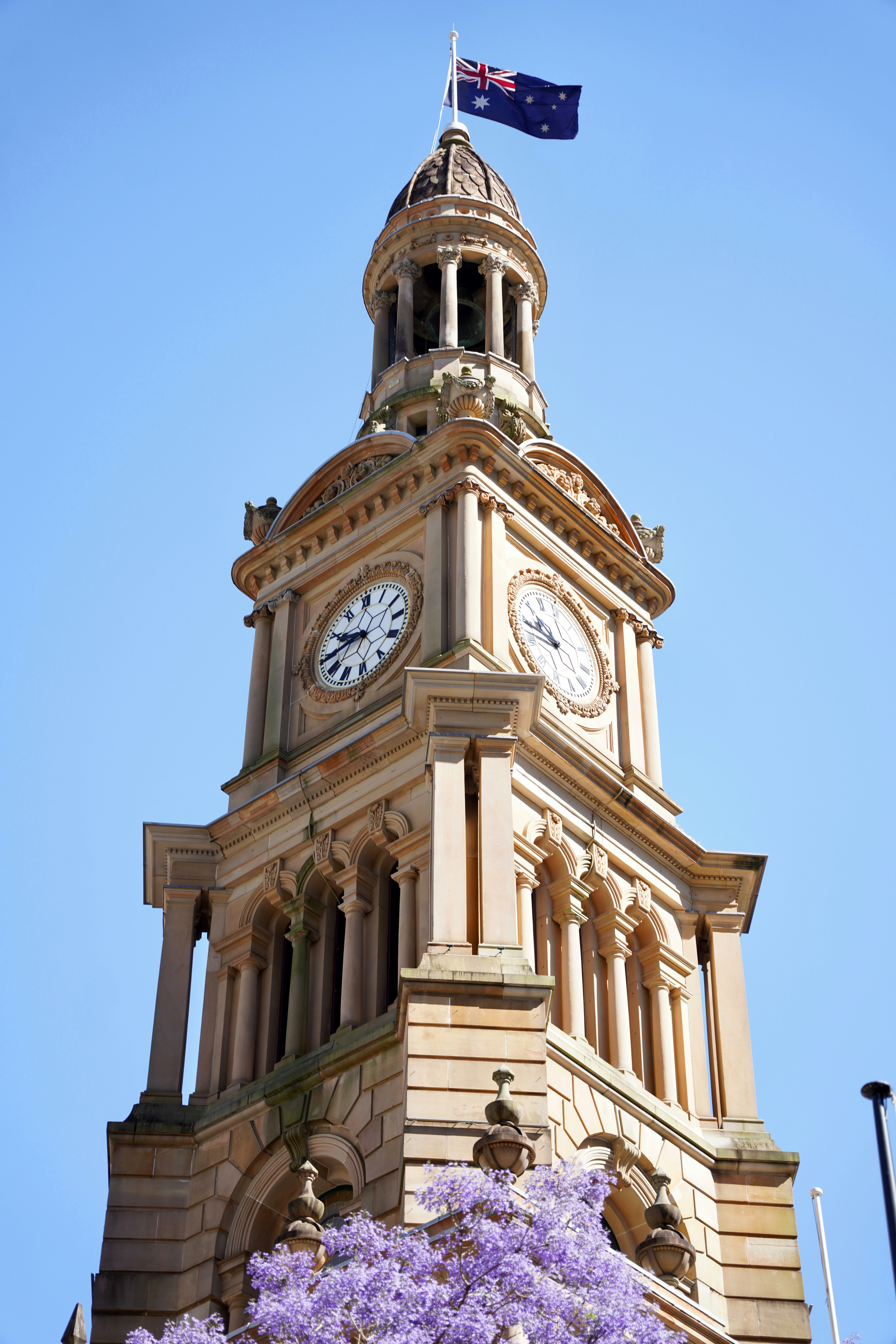 Clock tower with australian flag under blue sky